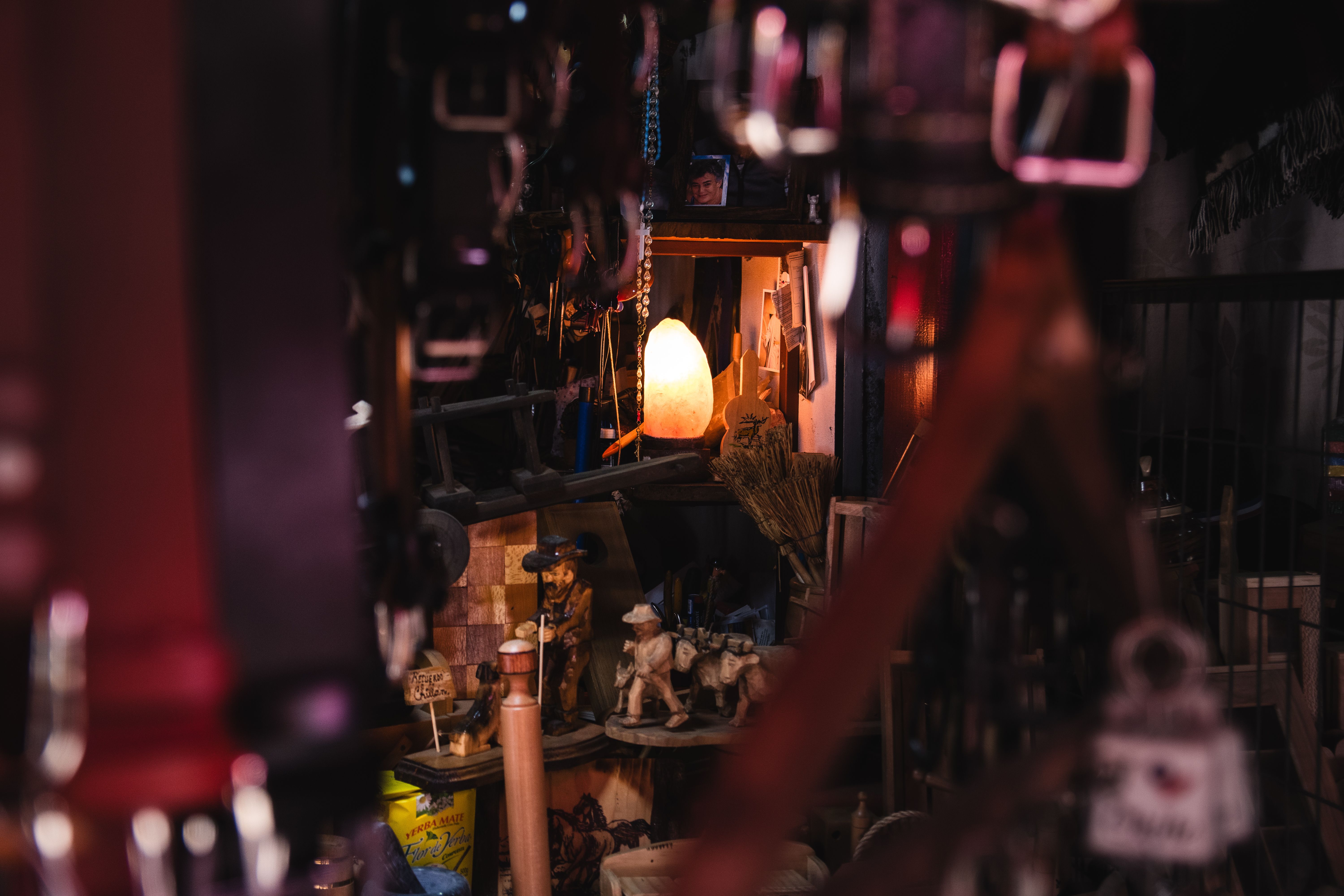 A lamp is lit in a dark room with many other items · Free Stock Photo