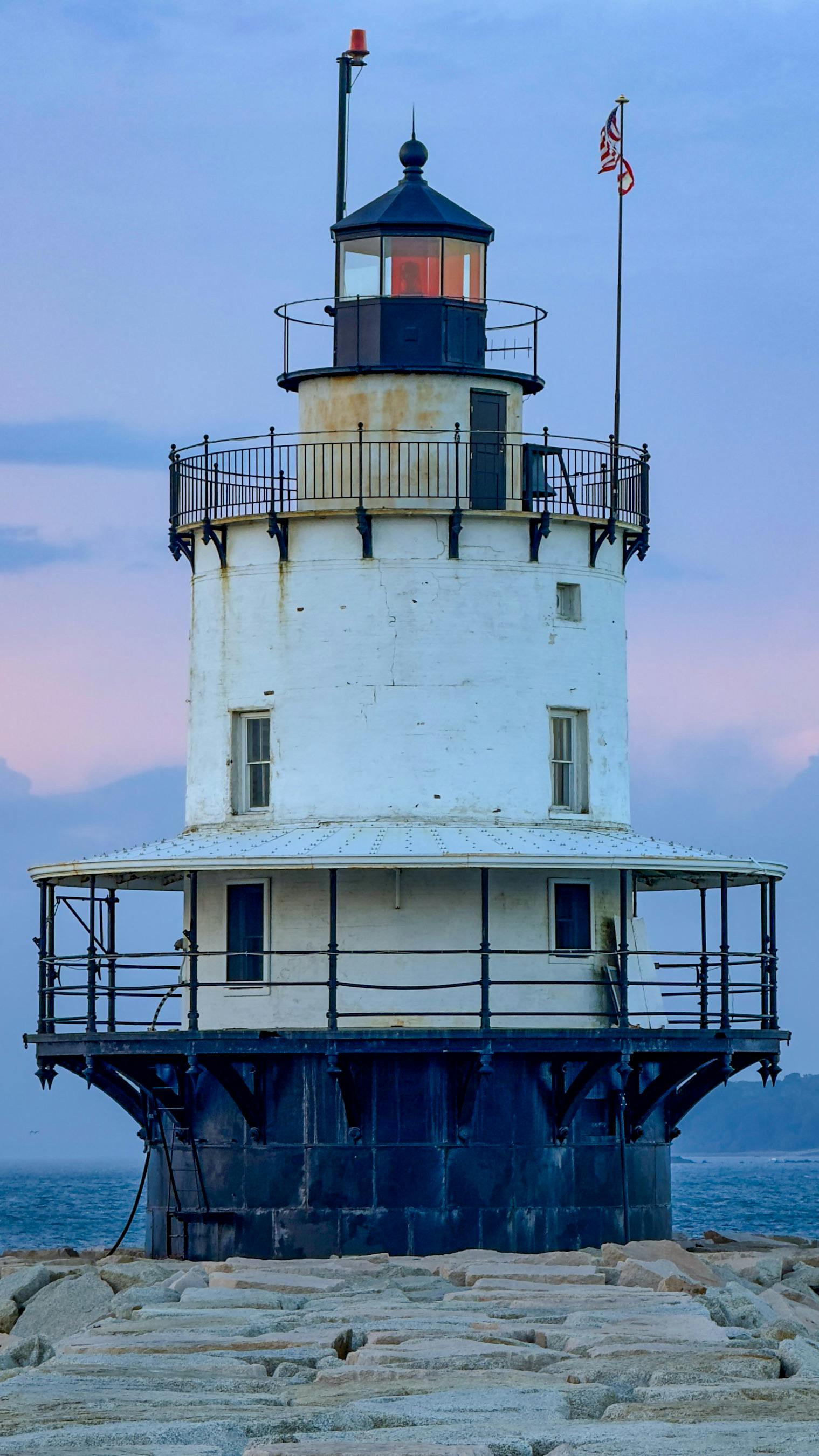 White and Black Striped Lighthouse Beside White House · Free Stock Photo