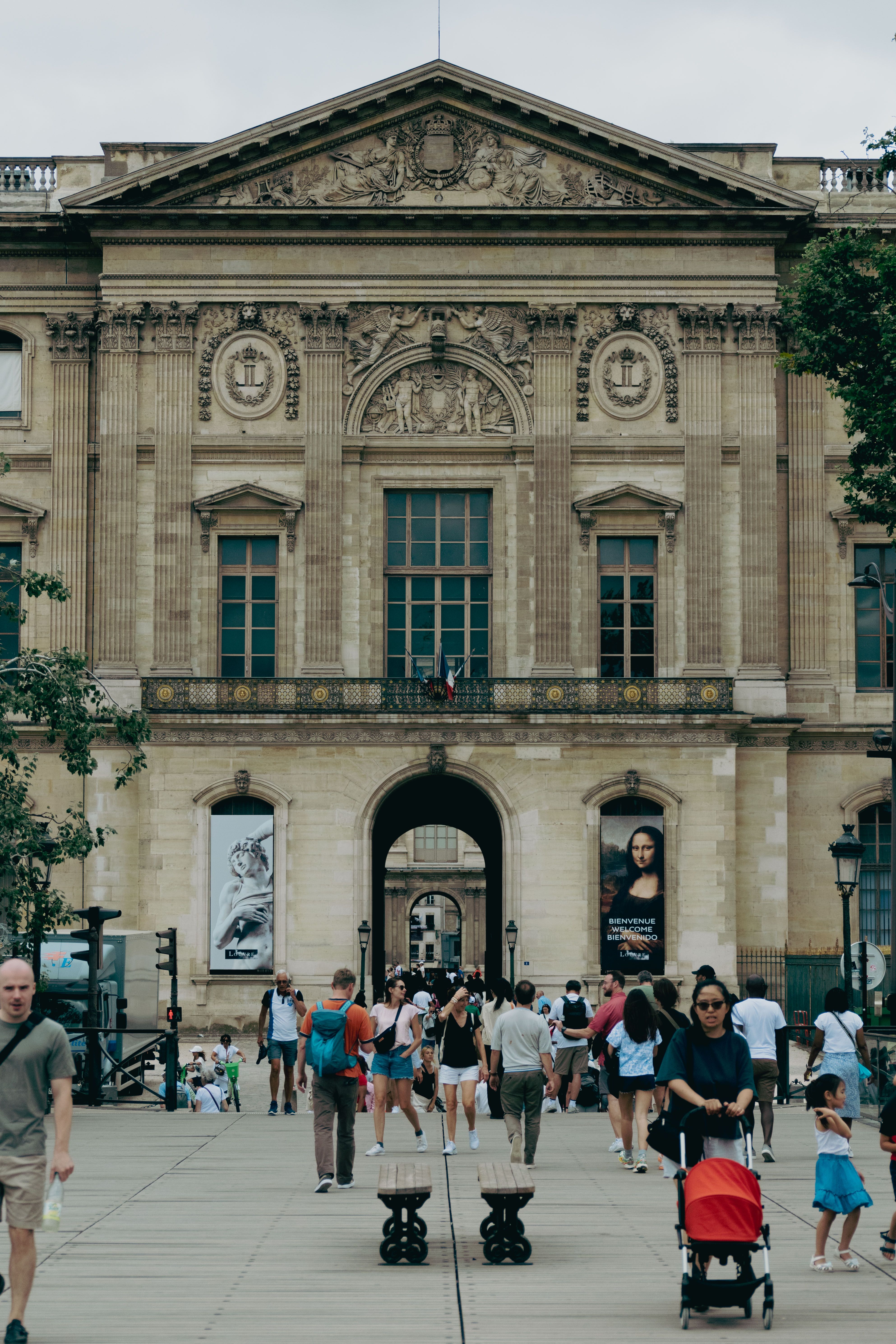 People walking in front of a large building · Free Stock Photo