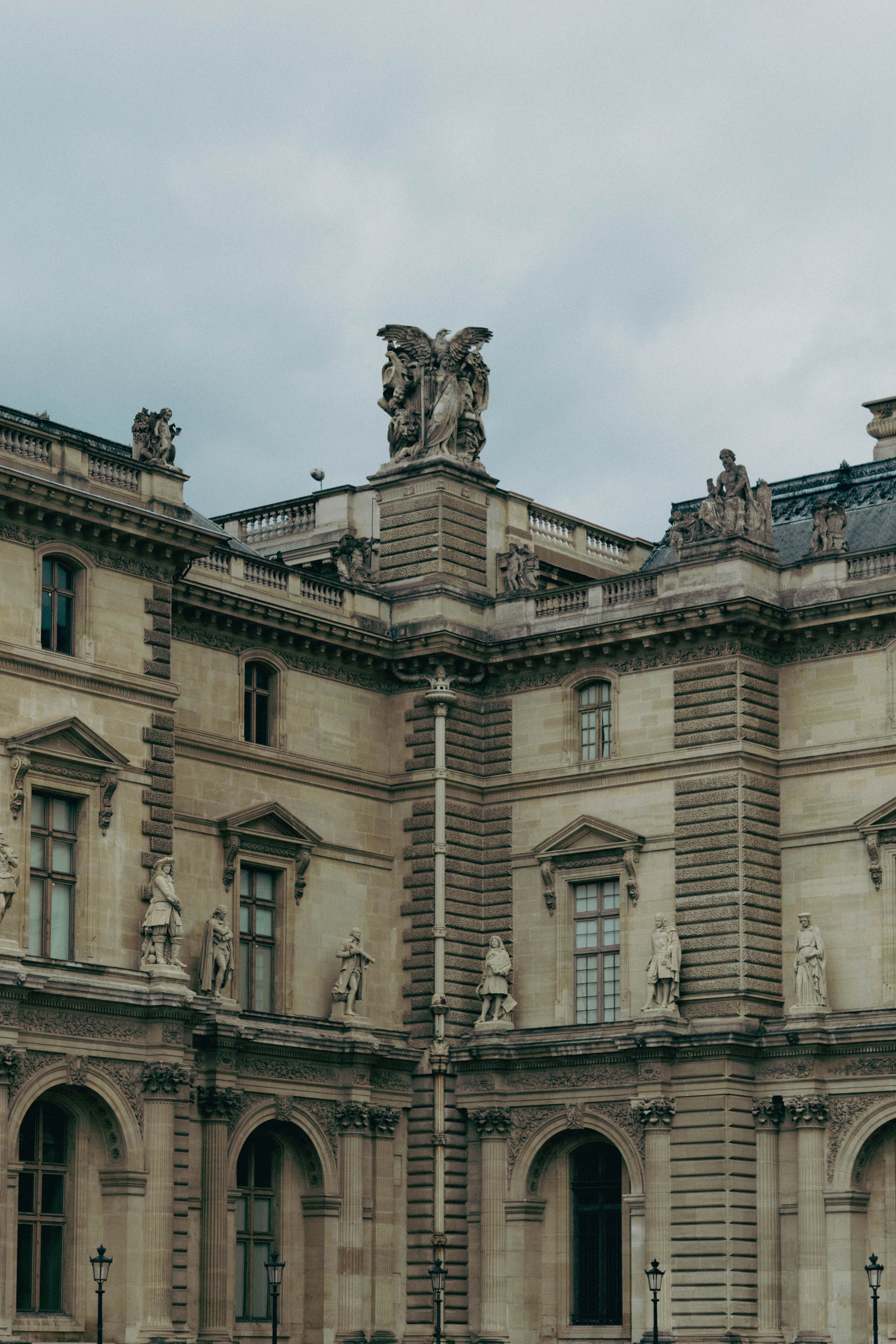 A large building with statues on it · Free Stock Photo