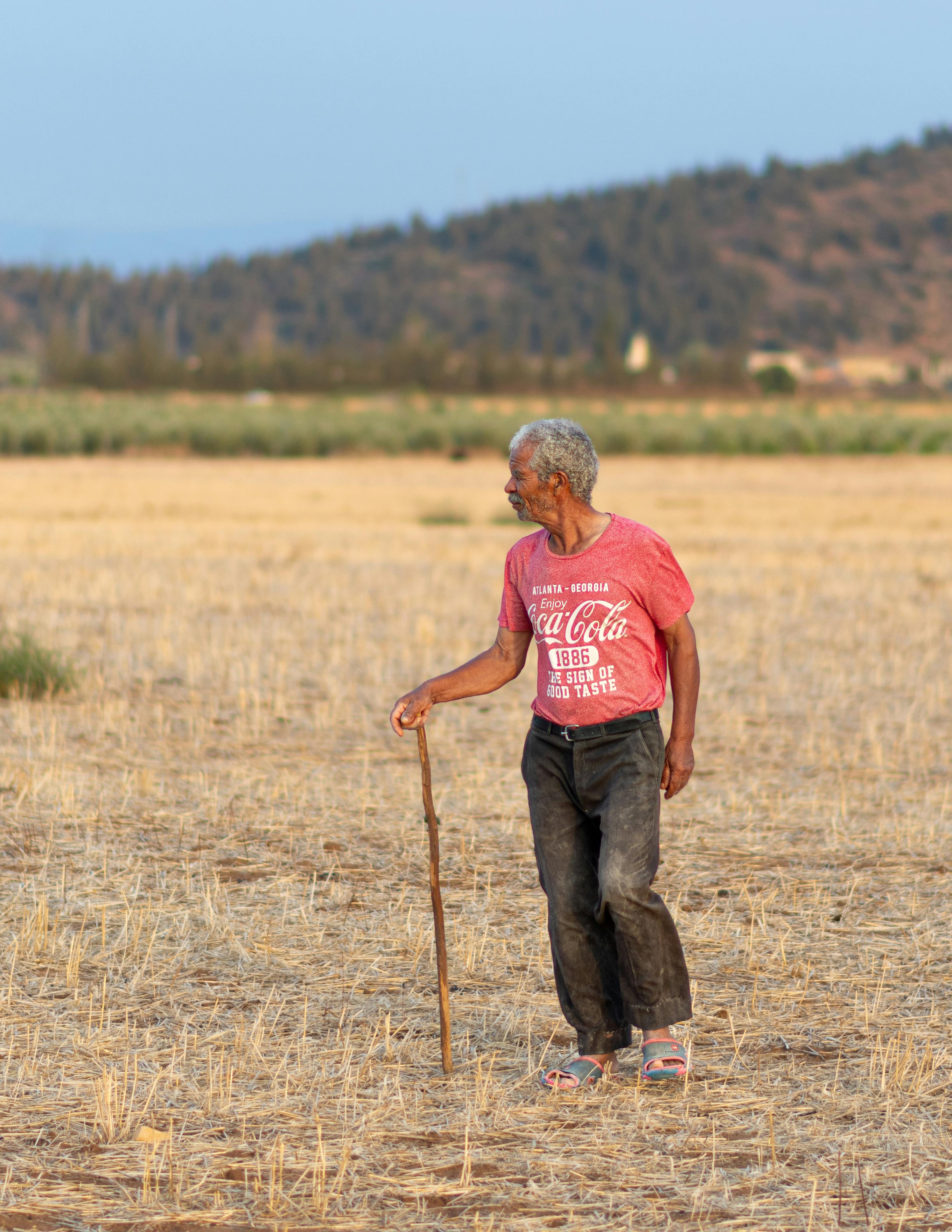 Elder Shepherd leaning on a stick · Free Stock Photo