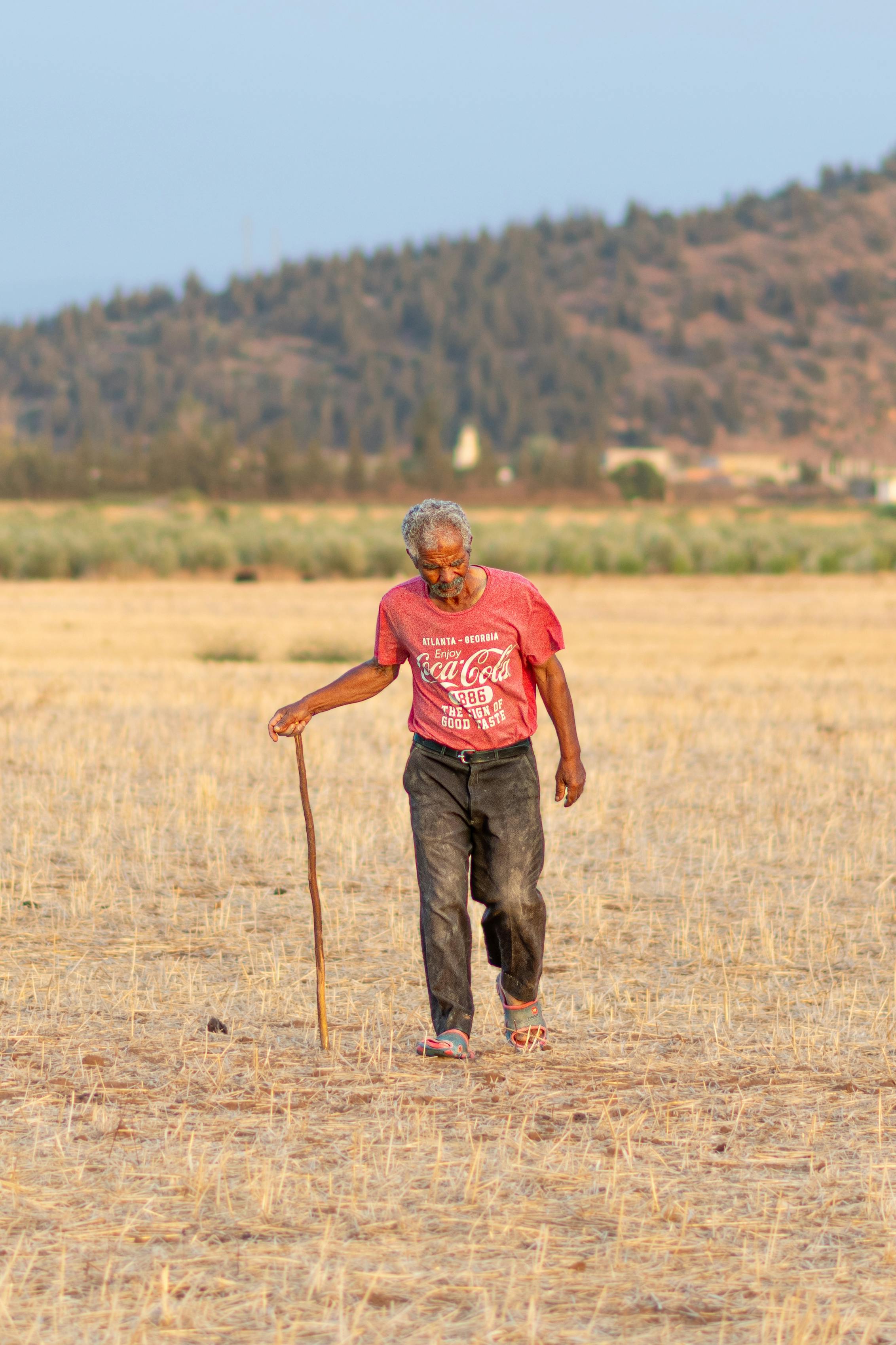Elder Shepherd leaning on a stick. · Free Stock Photo