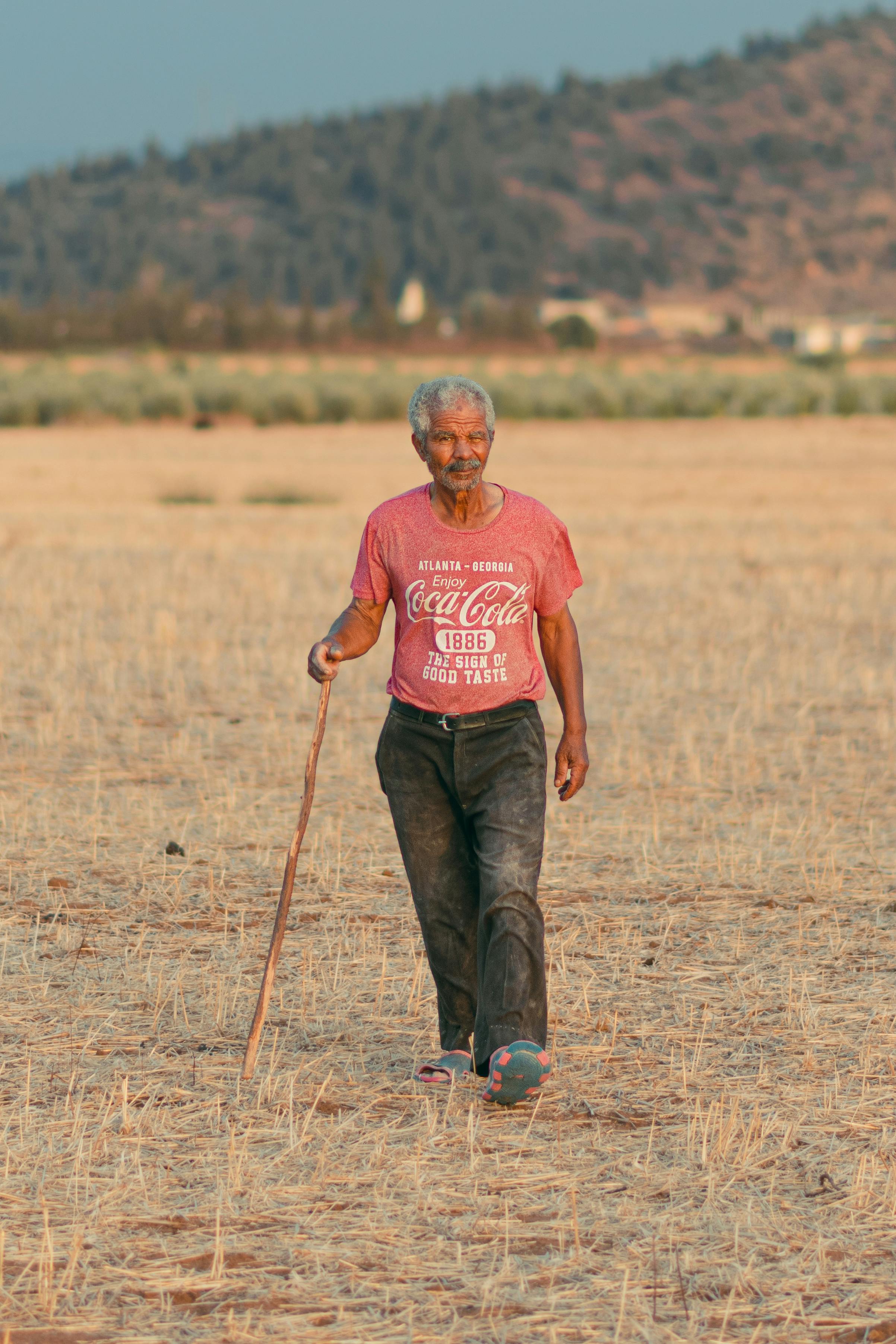 Elder Shepherd leaning on a stick. · Free Stock Photo