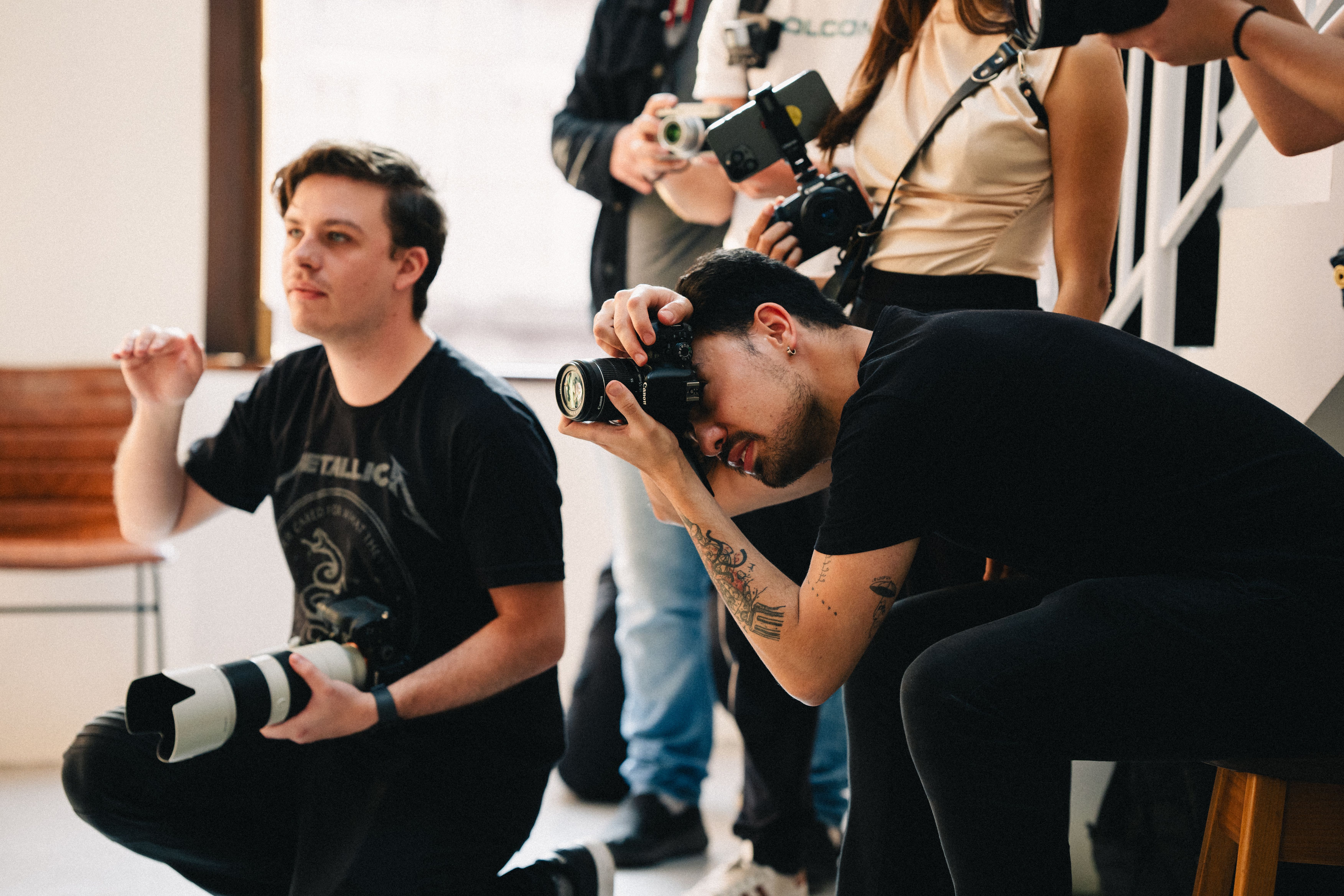 A group of people taking pictures of a camera · Free Stock Photo