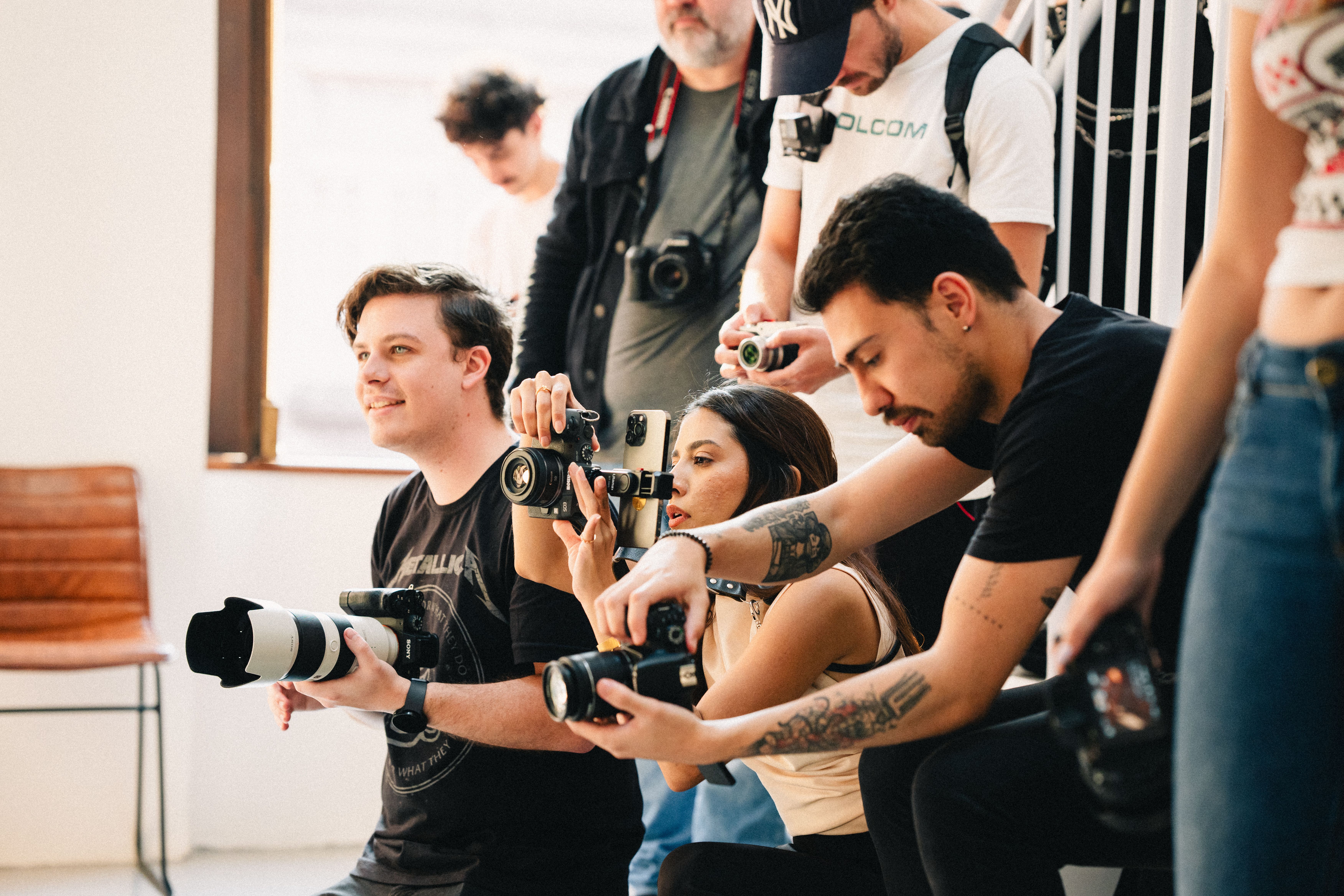 A group of people taking pictures with cameras · Free Stock Photo