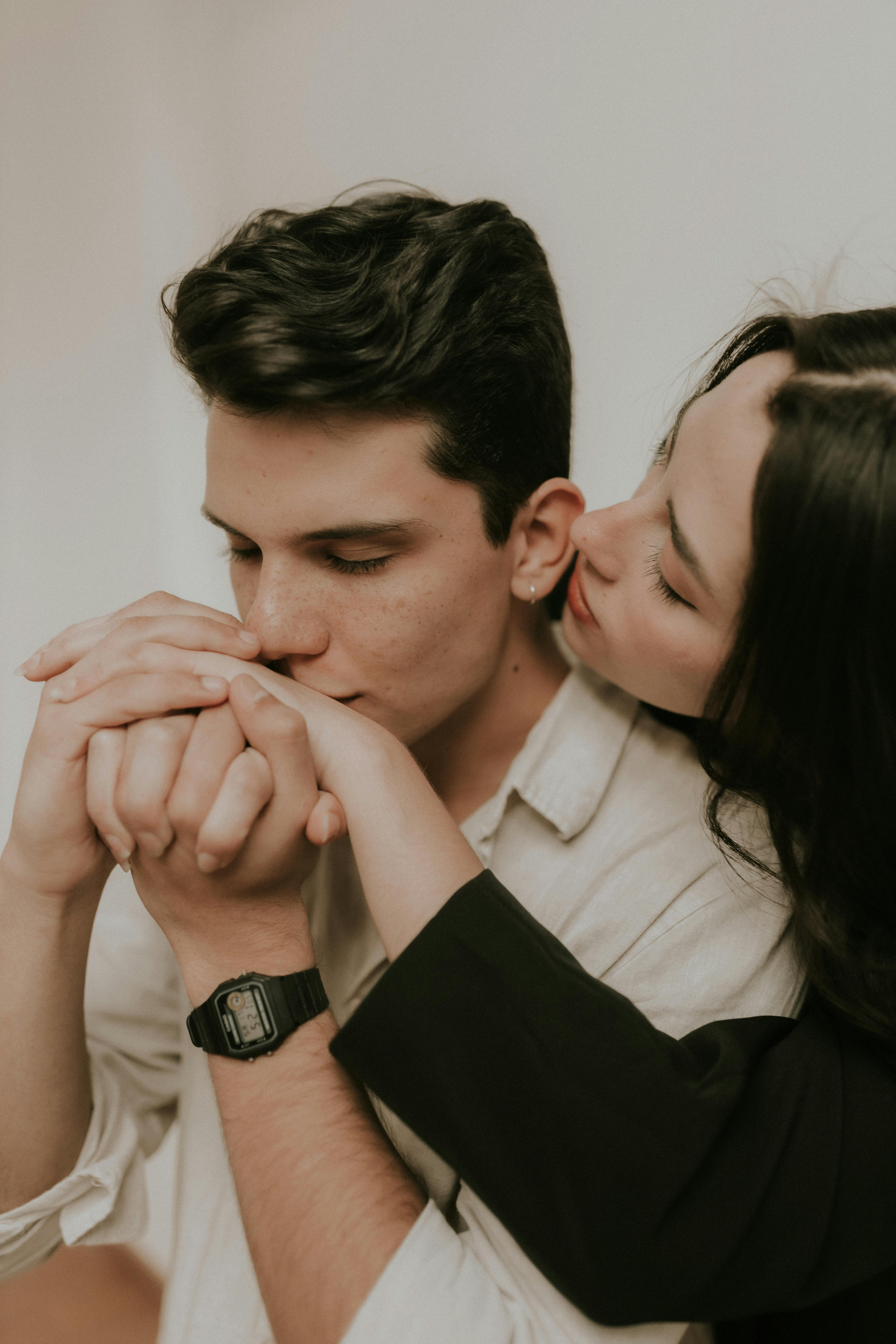 Young Man Kissing Hand of Woman Hugging him · Free Stock Photo