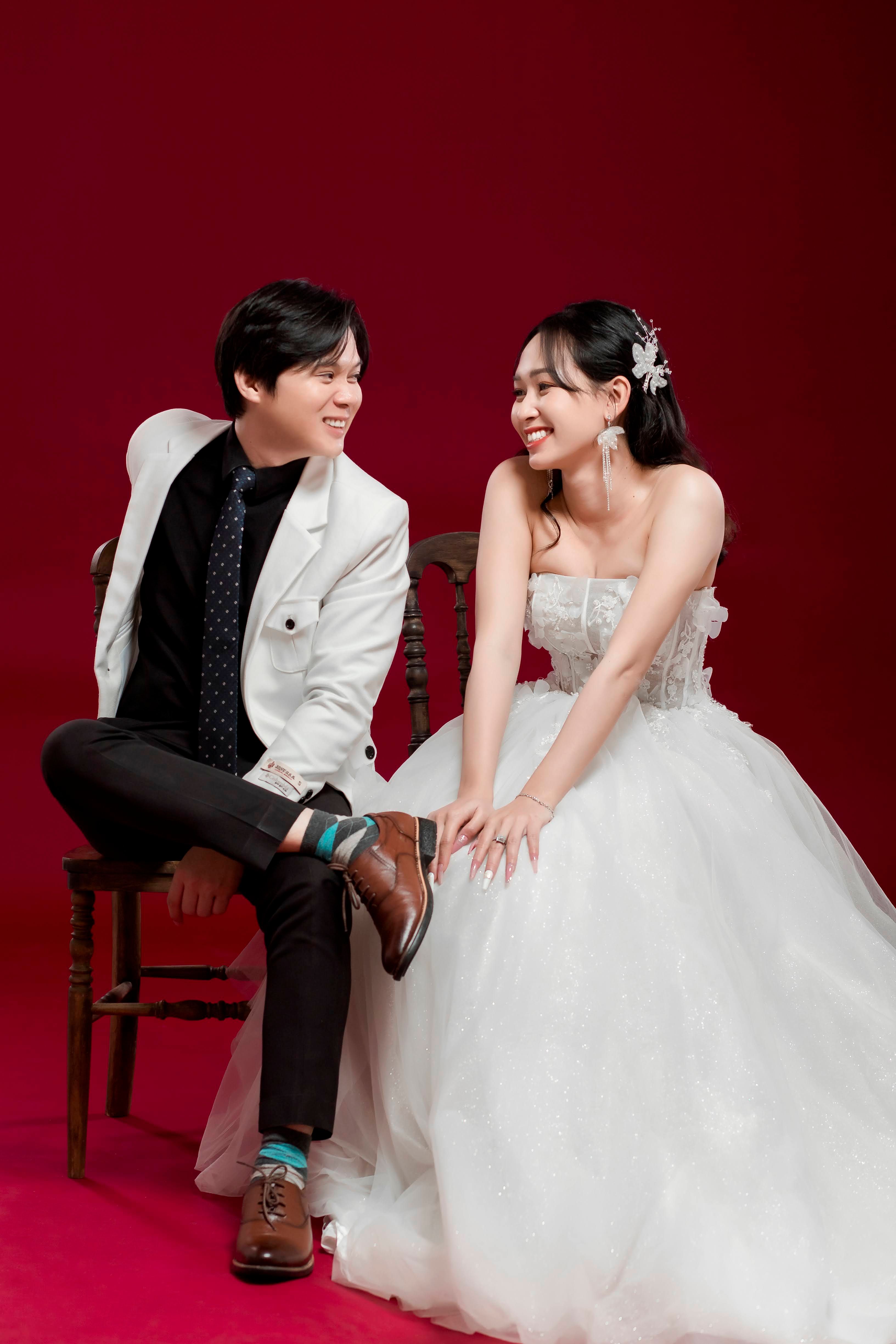 A man and woman in wedding attire pose for a photo · Free Stock Photo