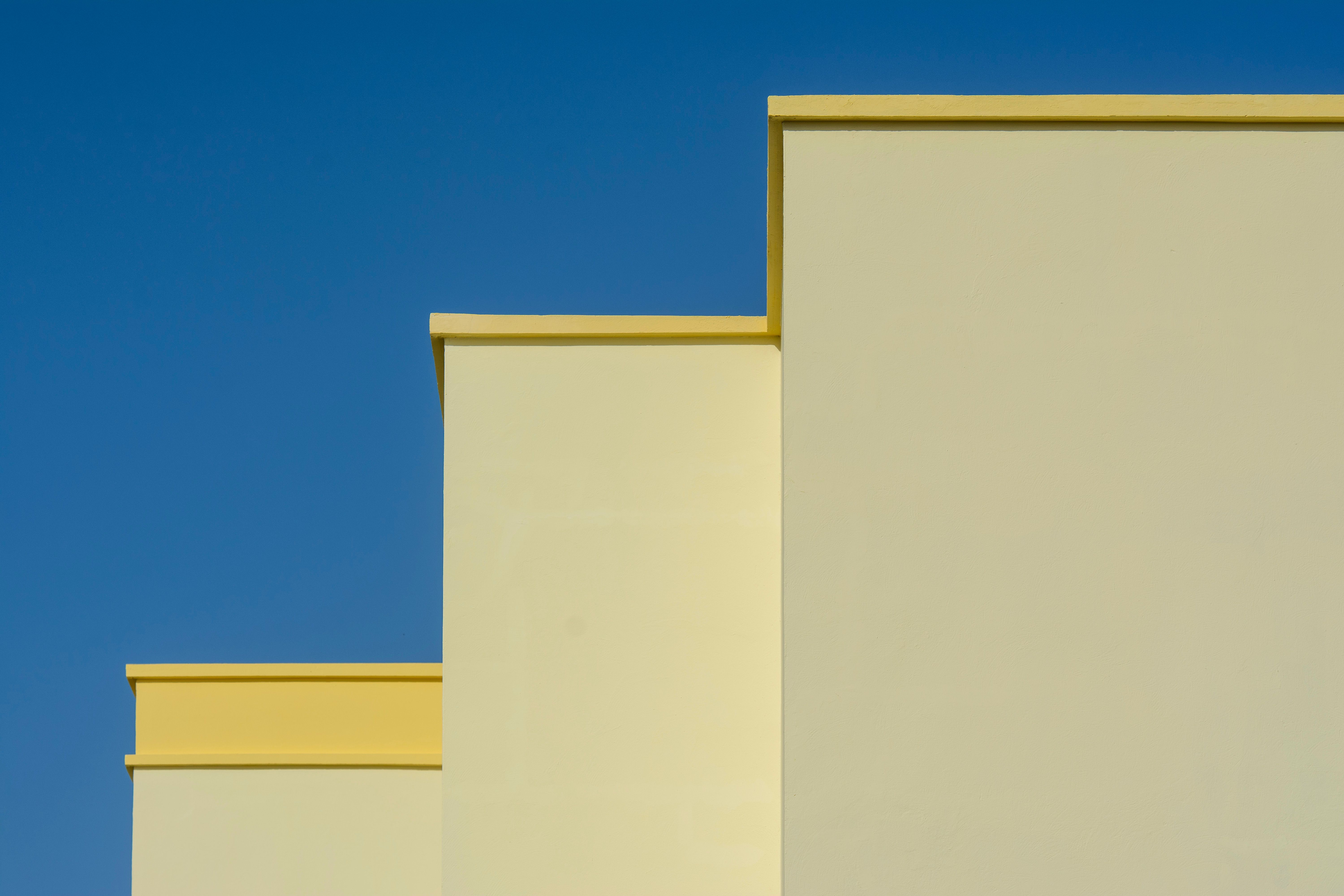 A close up of a yellow building with blue sky · Free Stock Photo