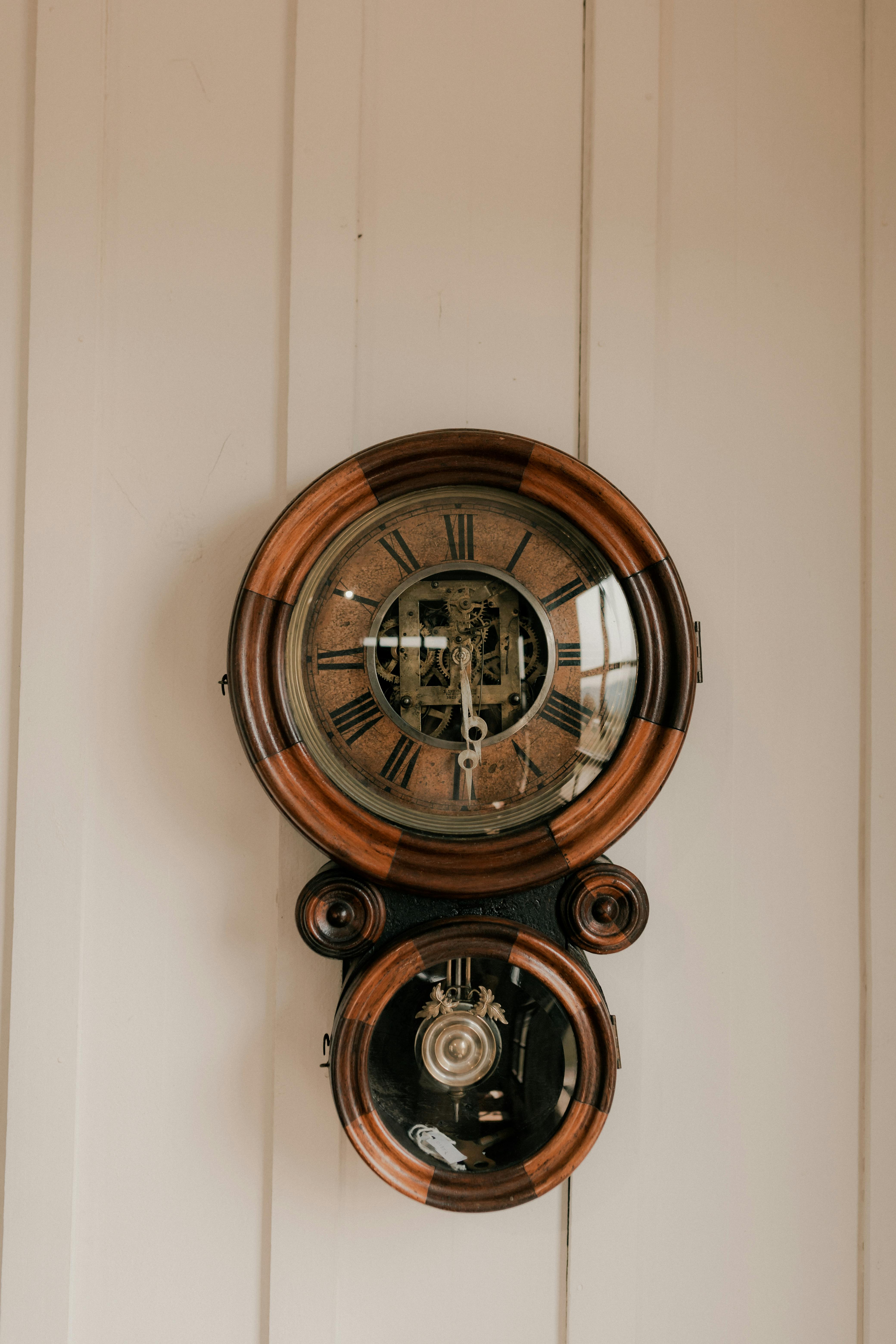 A clock hanging on the wall with a clock face · Free Stock Photo