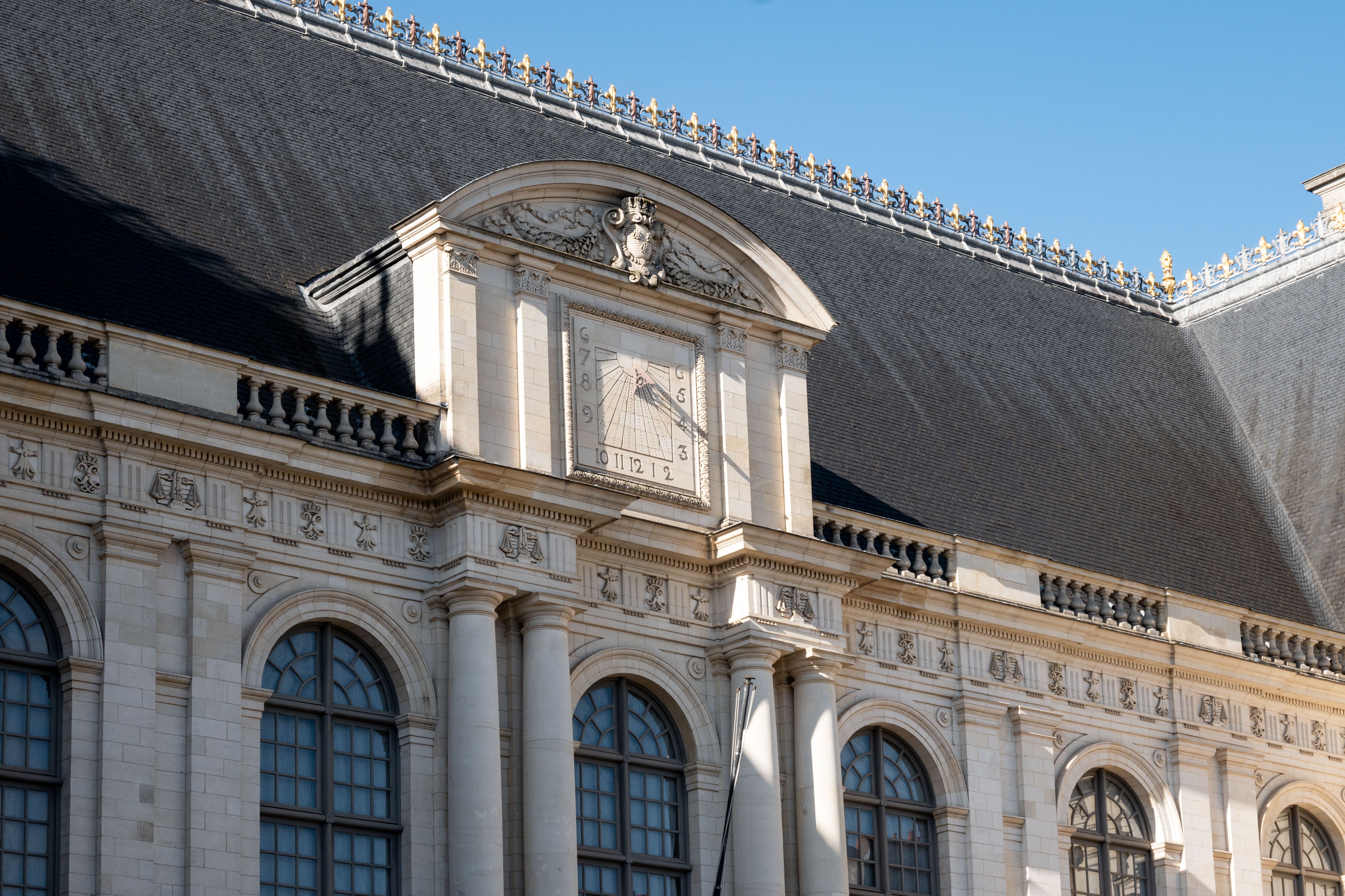 A building with a clock on it's roof · Free Stock Photo