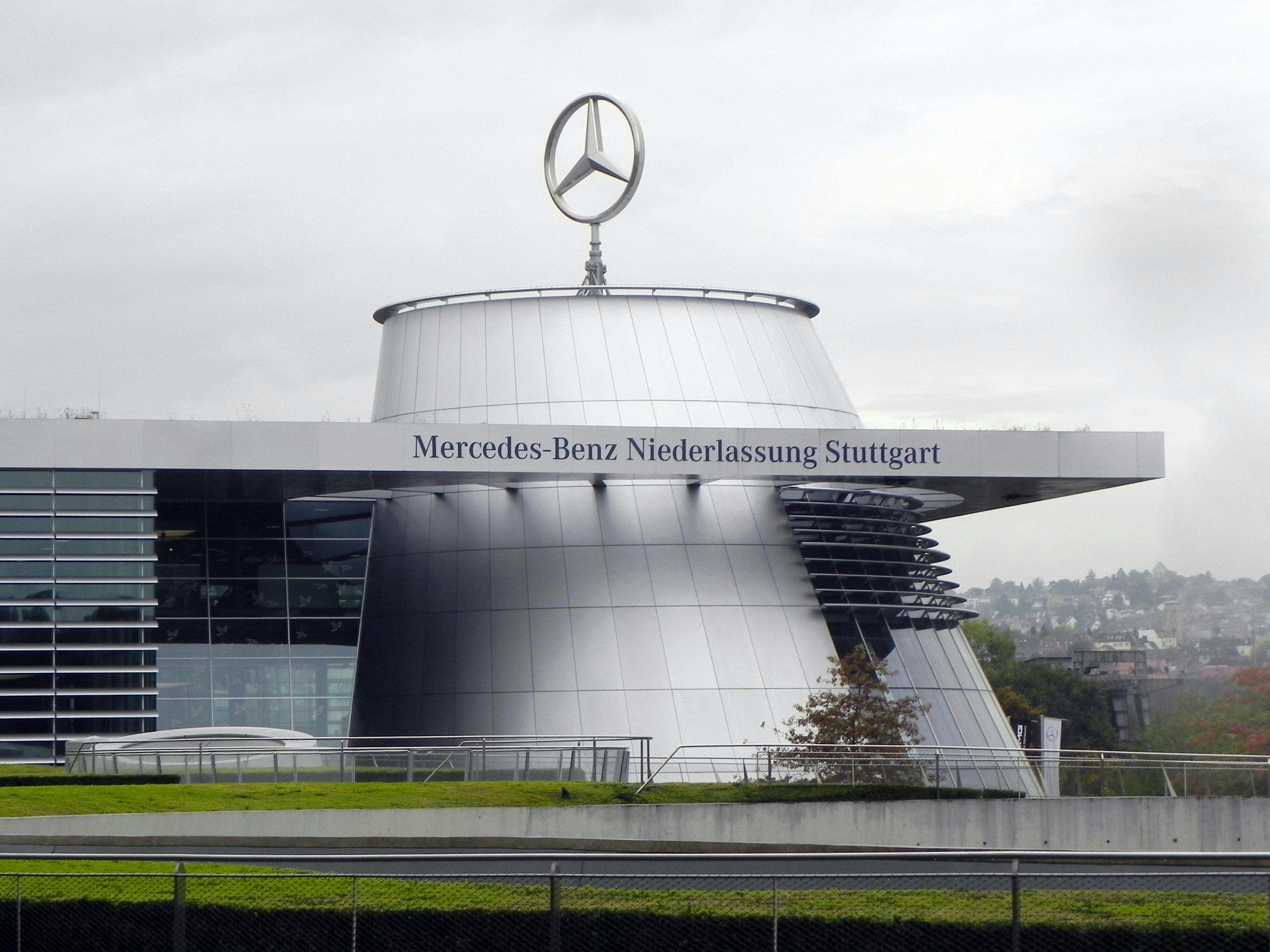 A mercedes benz building with a large sign on it · Free Stock Photo