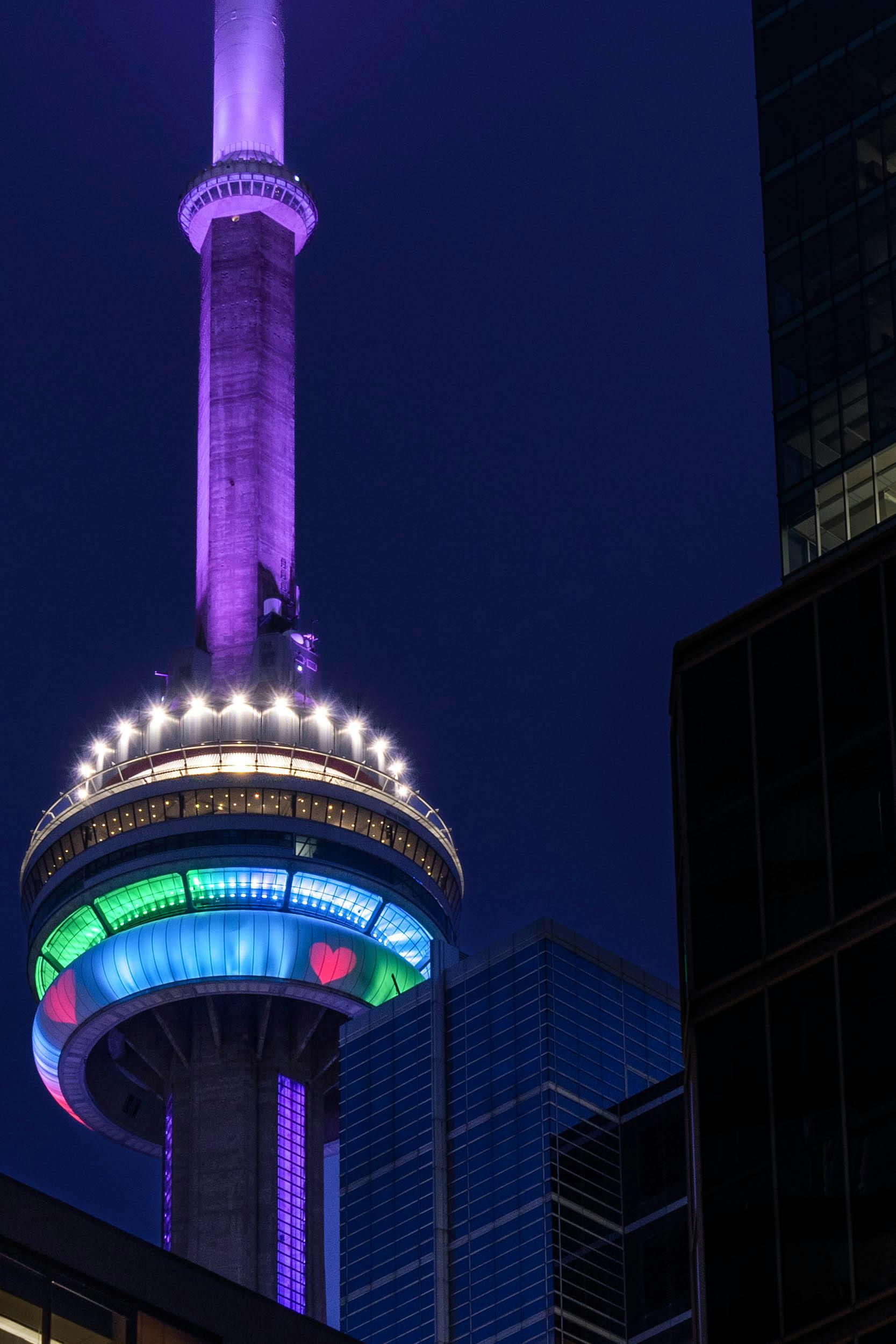 The cn tower lit up in purple and blue · Free Stock Photo