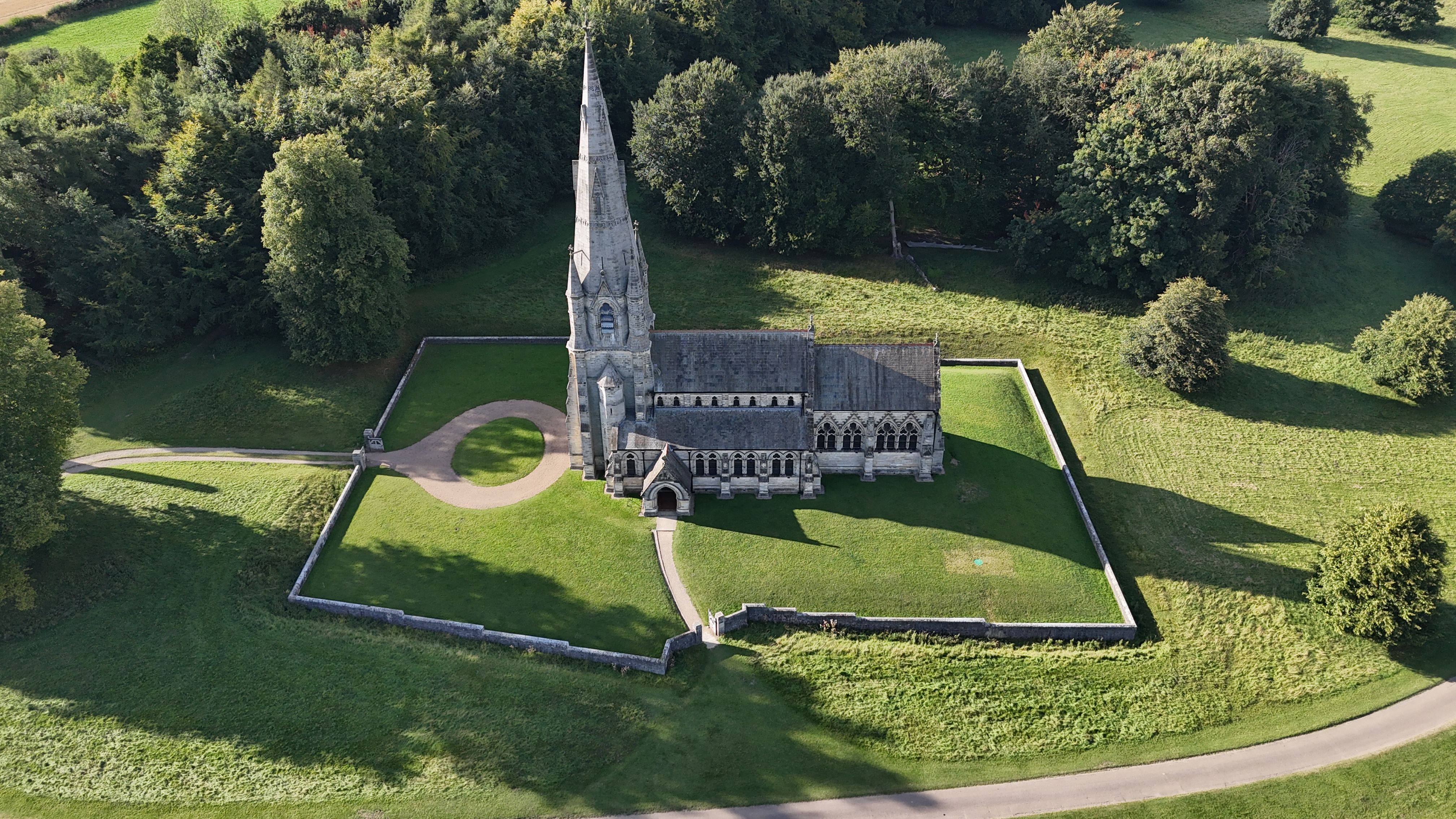 An aerial view of a church in the middle of a field · Free Stock Photo
