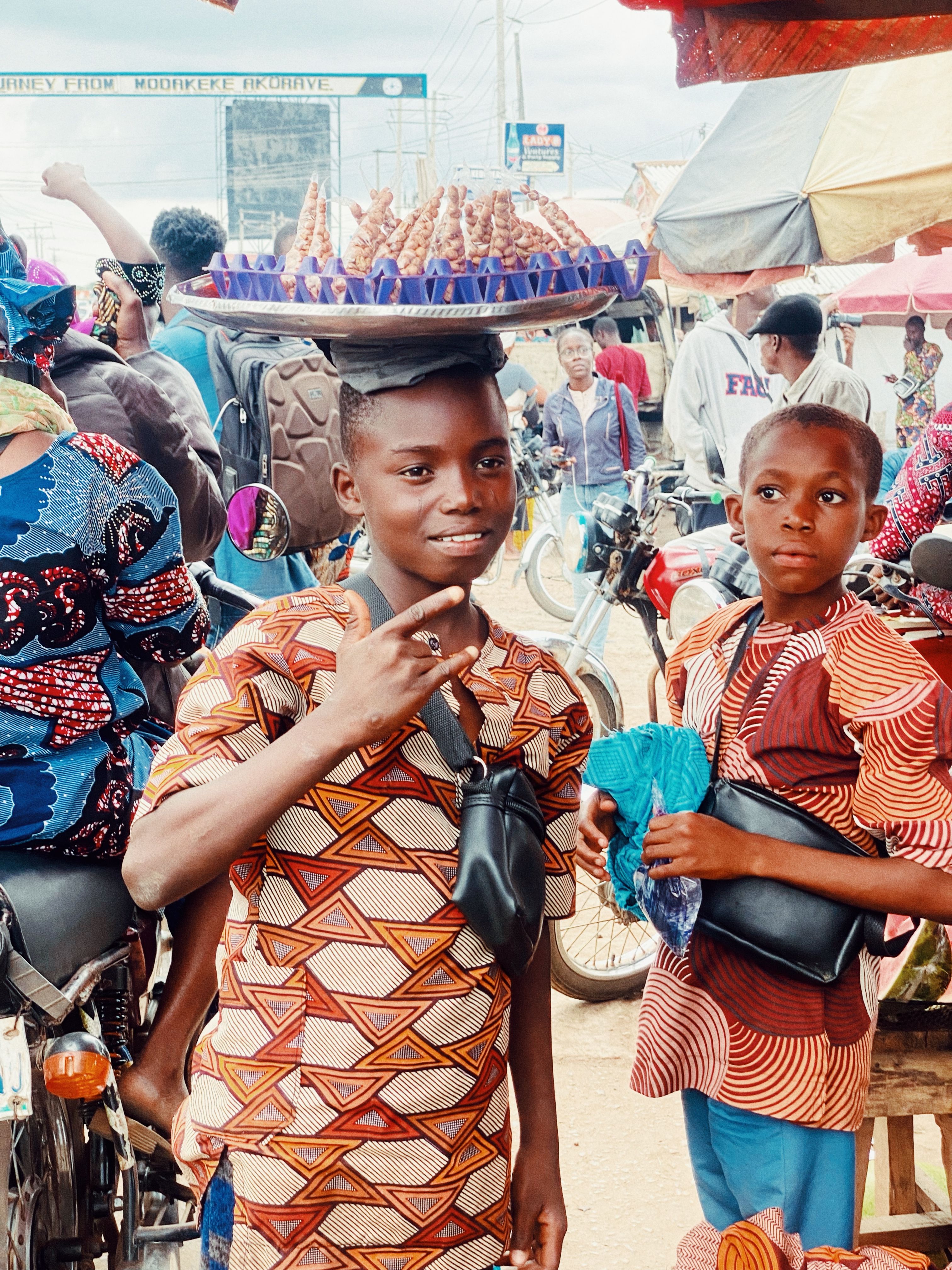 Two children standing in front of a market · Free Stock Photo