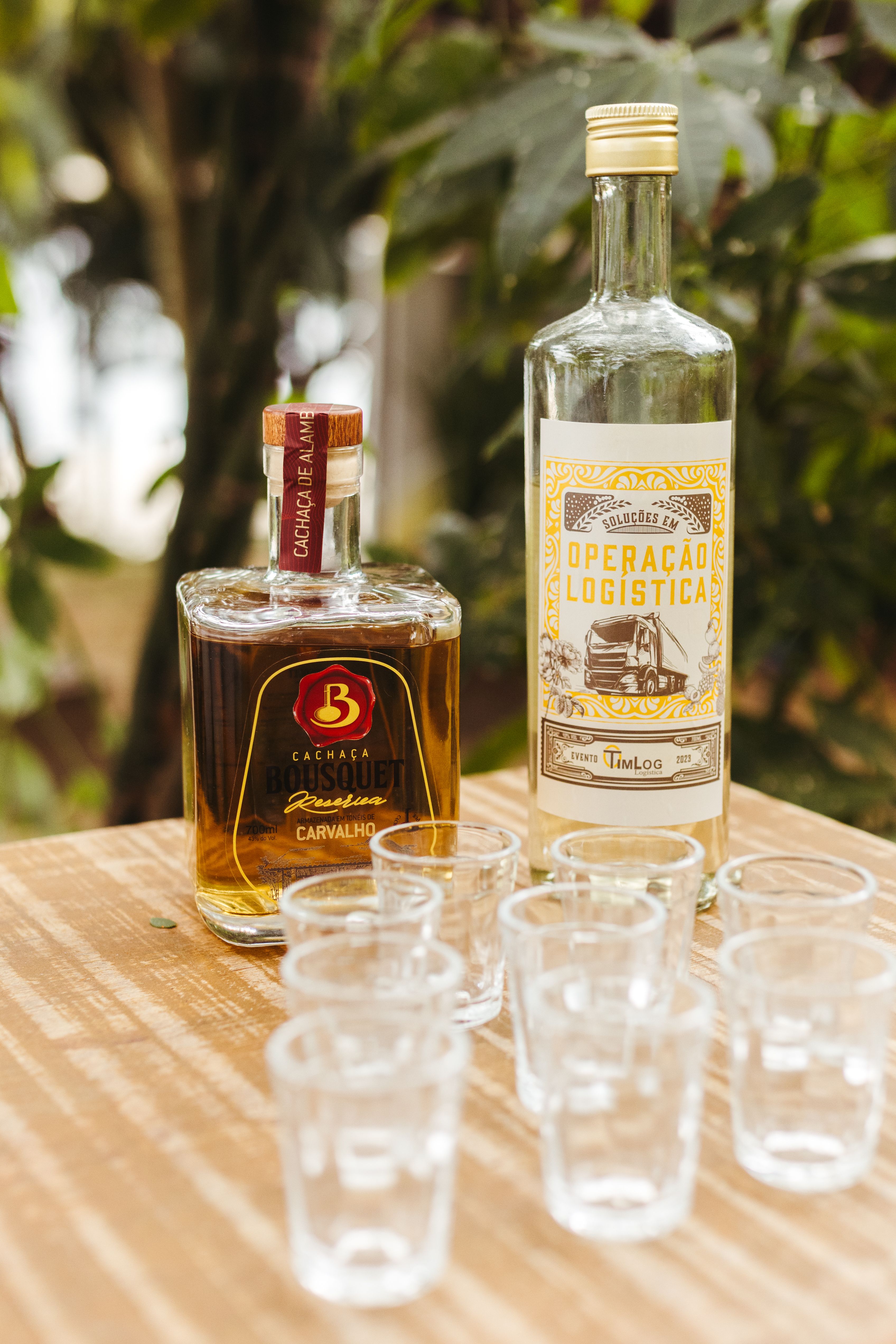 A bottle of rum and some shot glasses on a table · Free Stock Photo