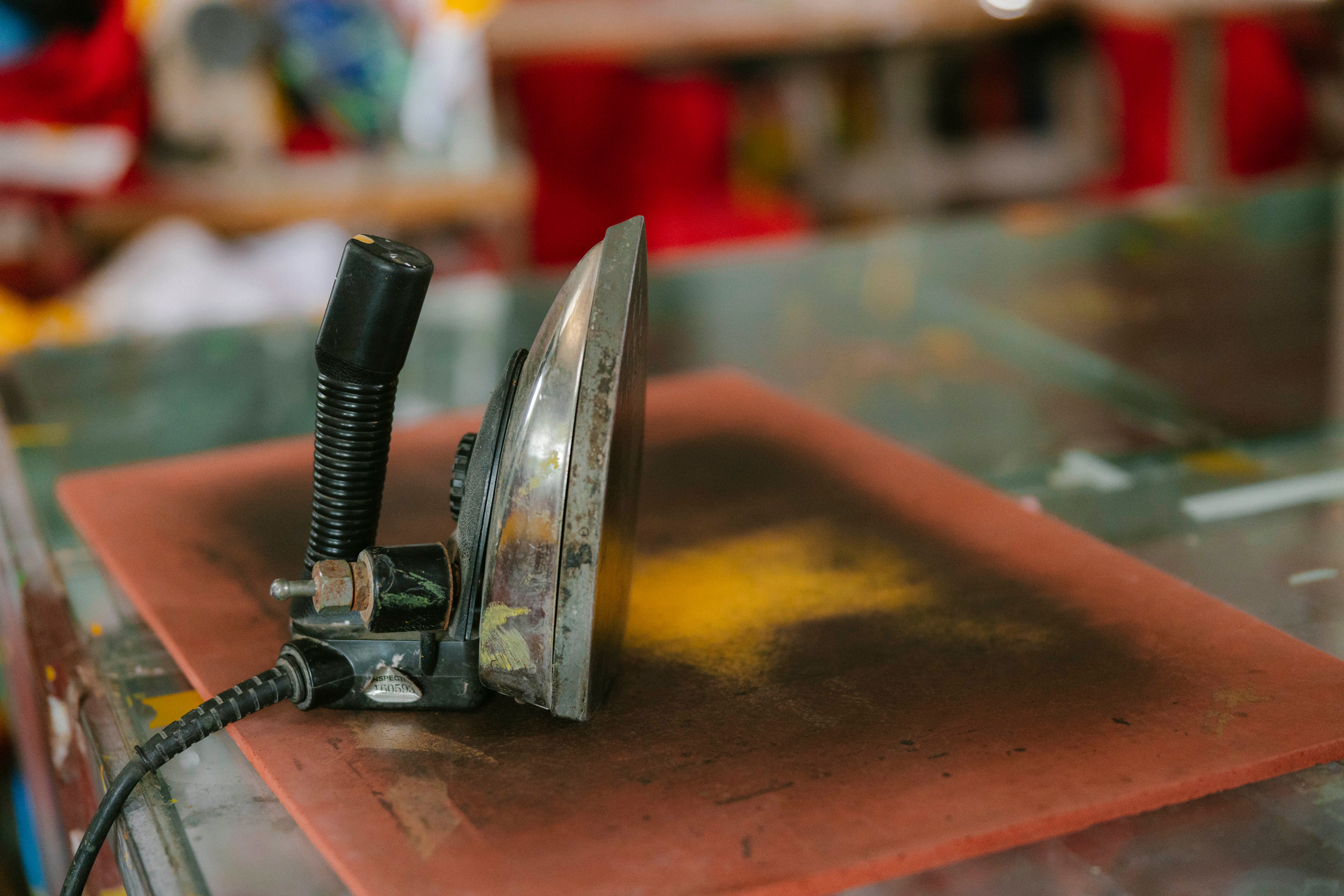 An iron is sitting on top of a table · Free Stock Photo
