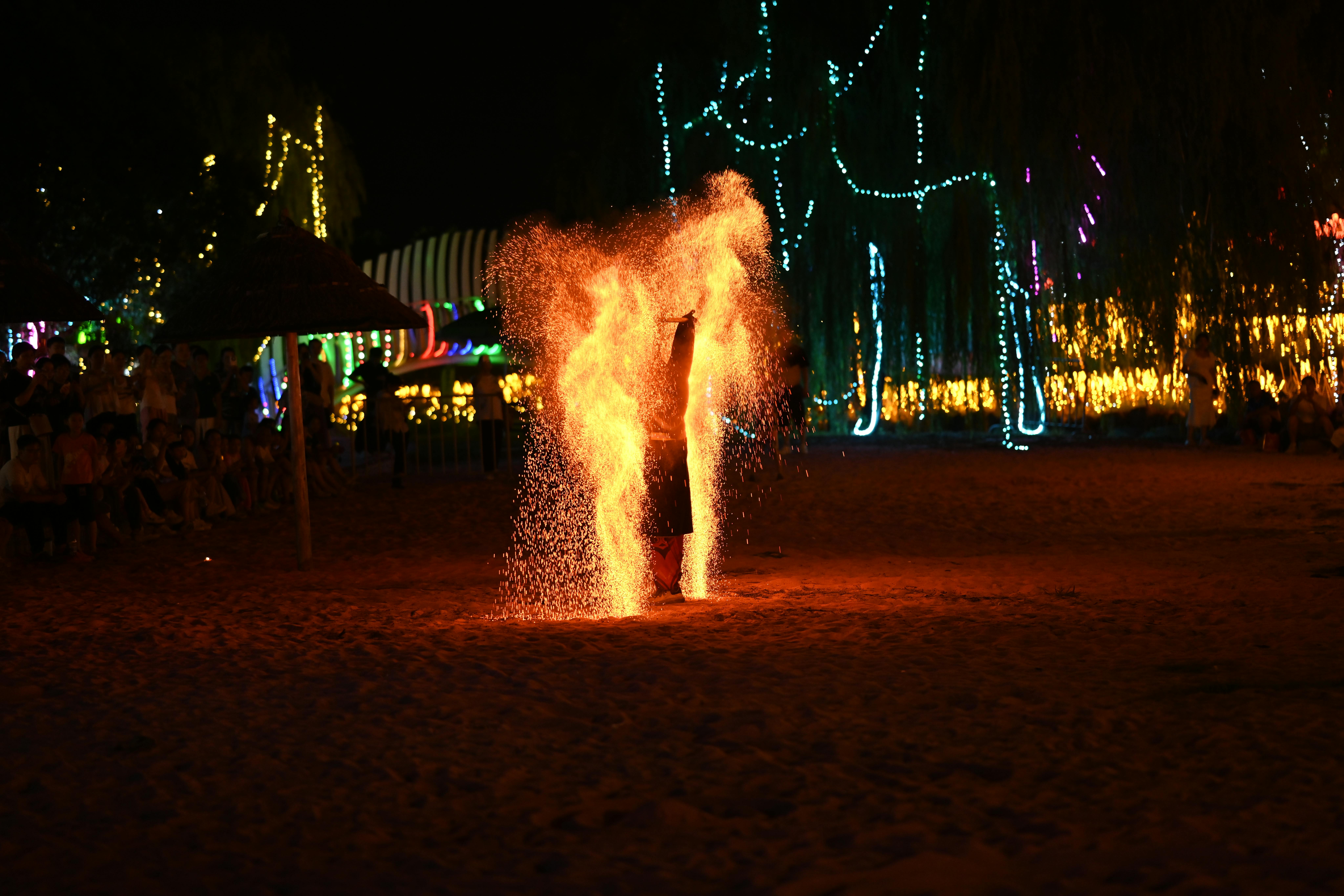 A fire show at night with lights and people · Free Stock Photo
