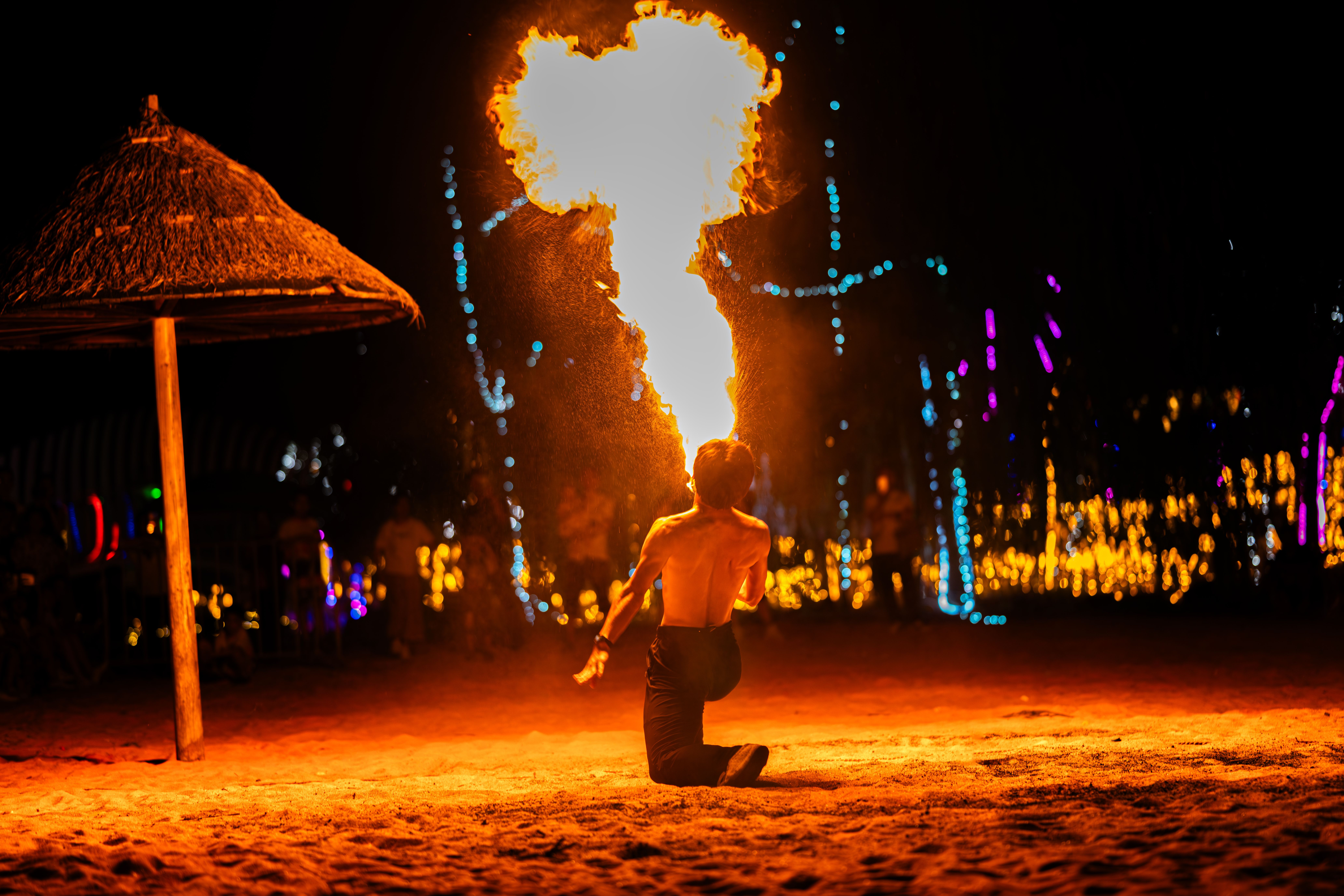 A man is performing fire on the beach · Free Stock Photo