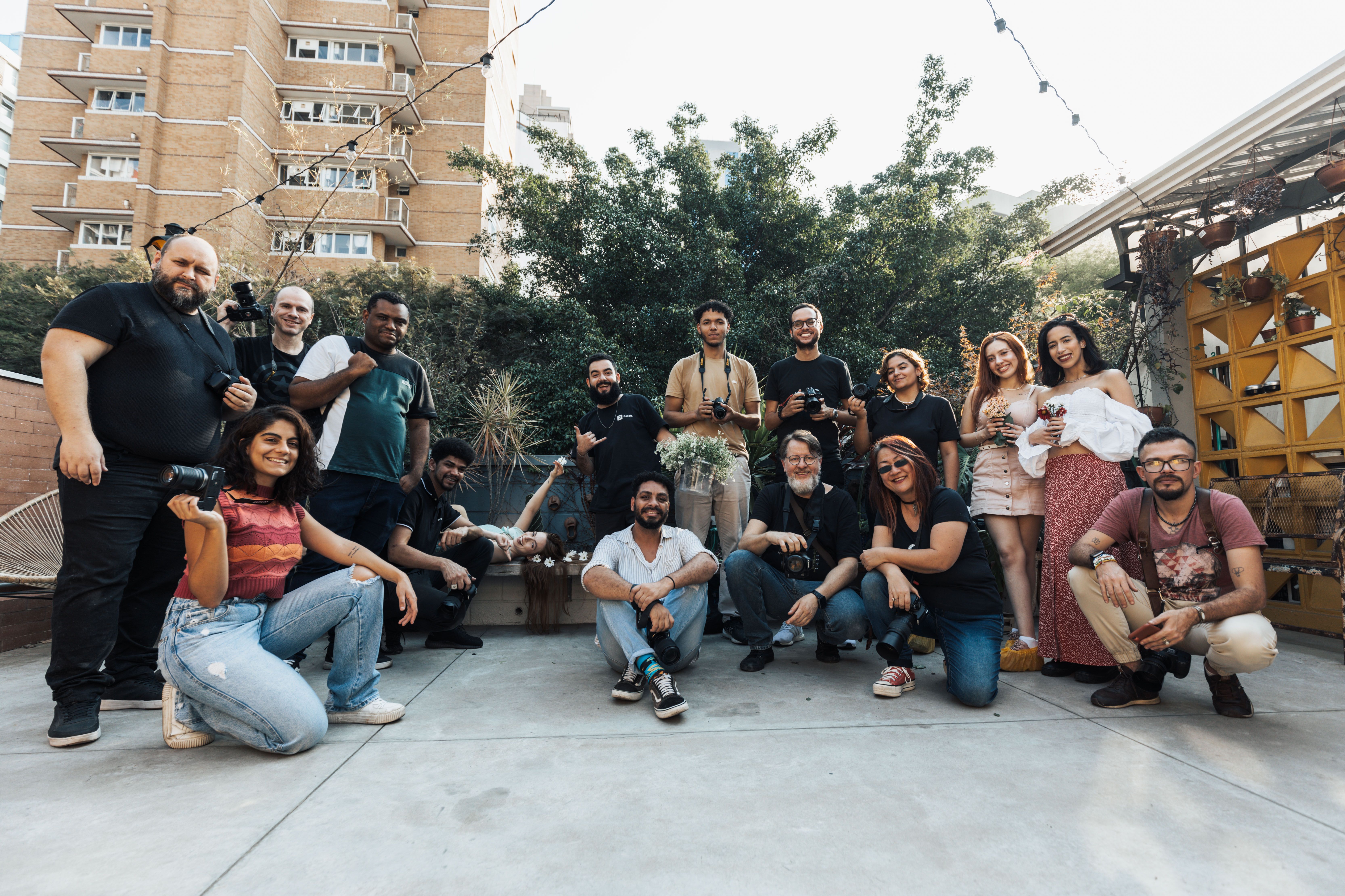 A group of people posing for a photo in a courtyard · Free Stock Photo