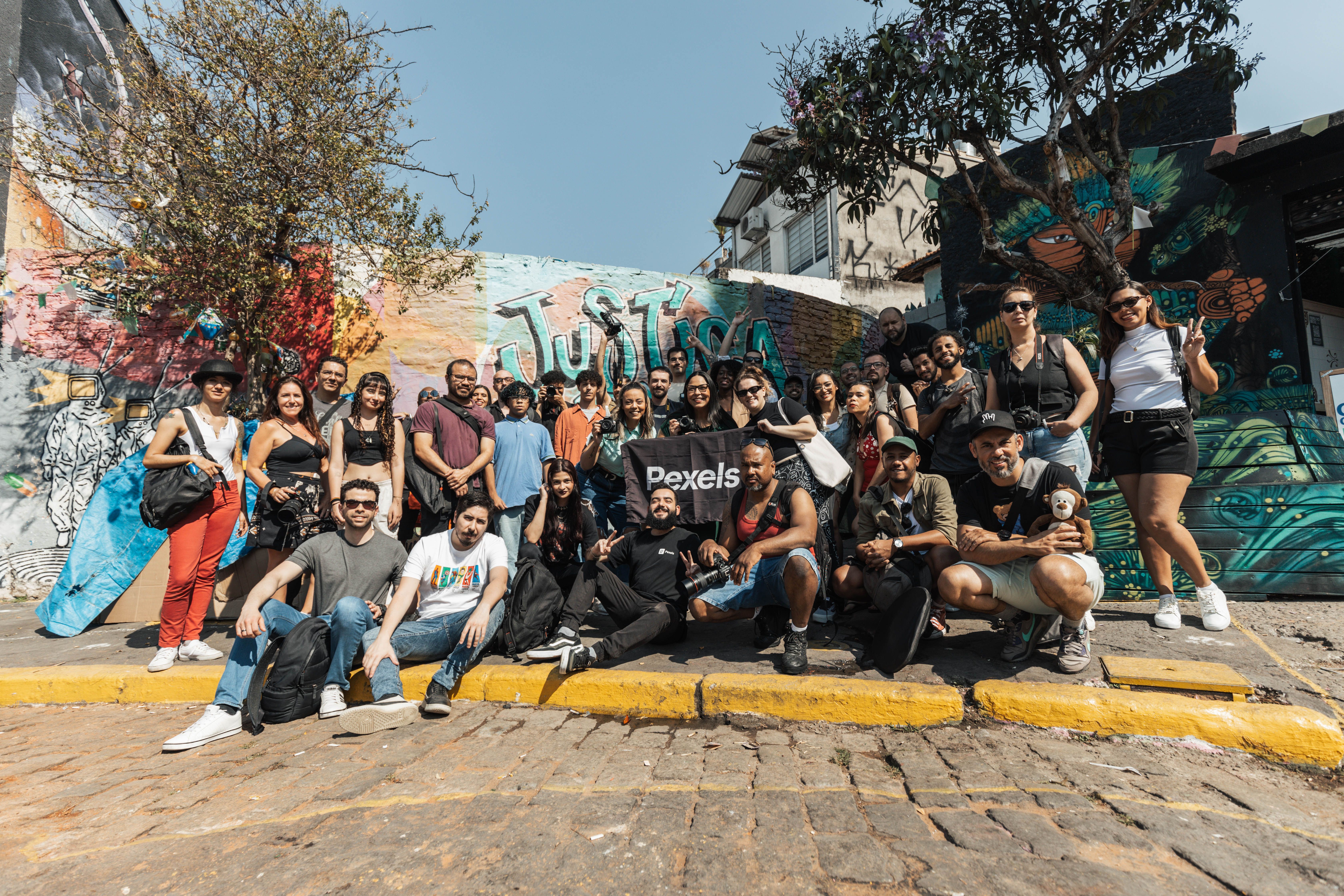 A group of people standing in front of a wall with graffiti · Free ...