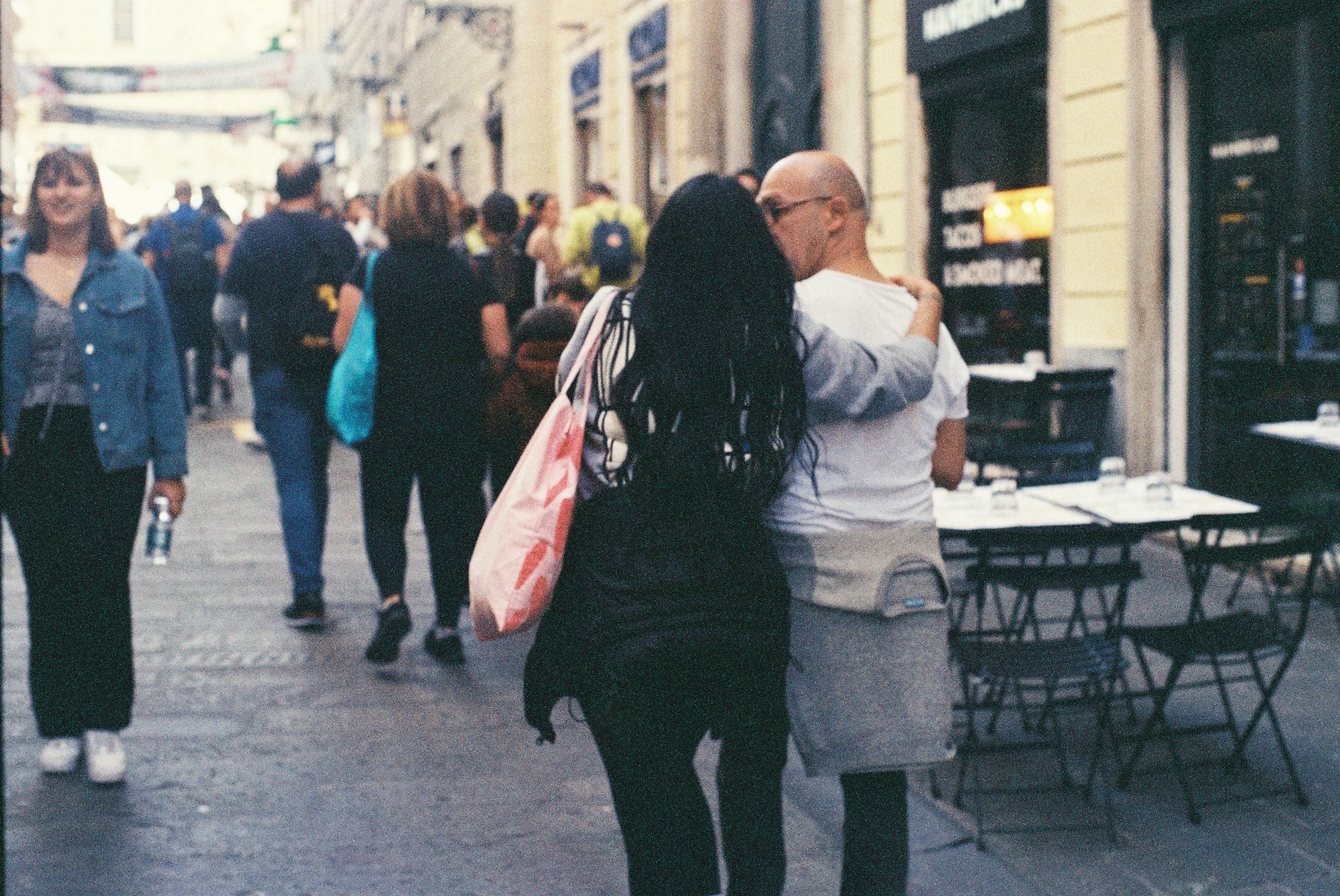 A woman hugs a man in a city street · Free Stock Photo
