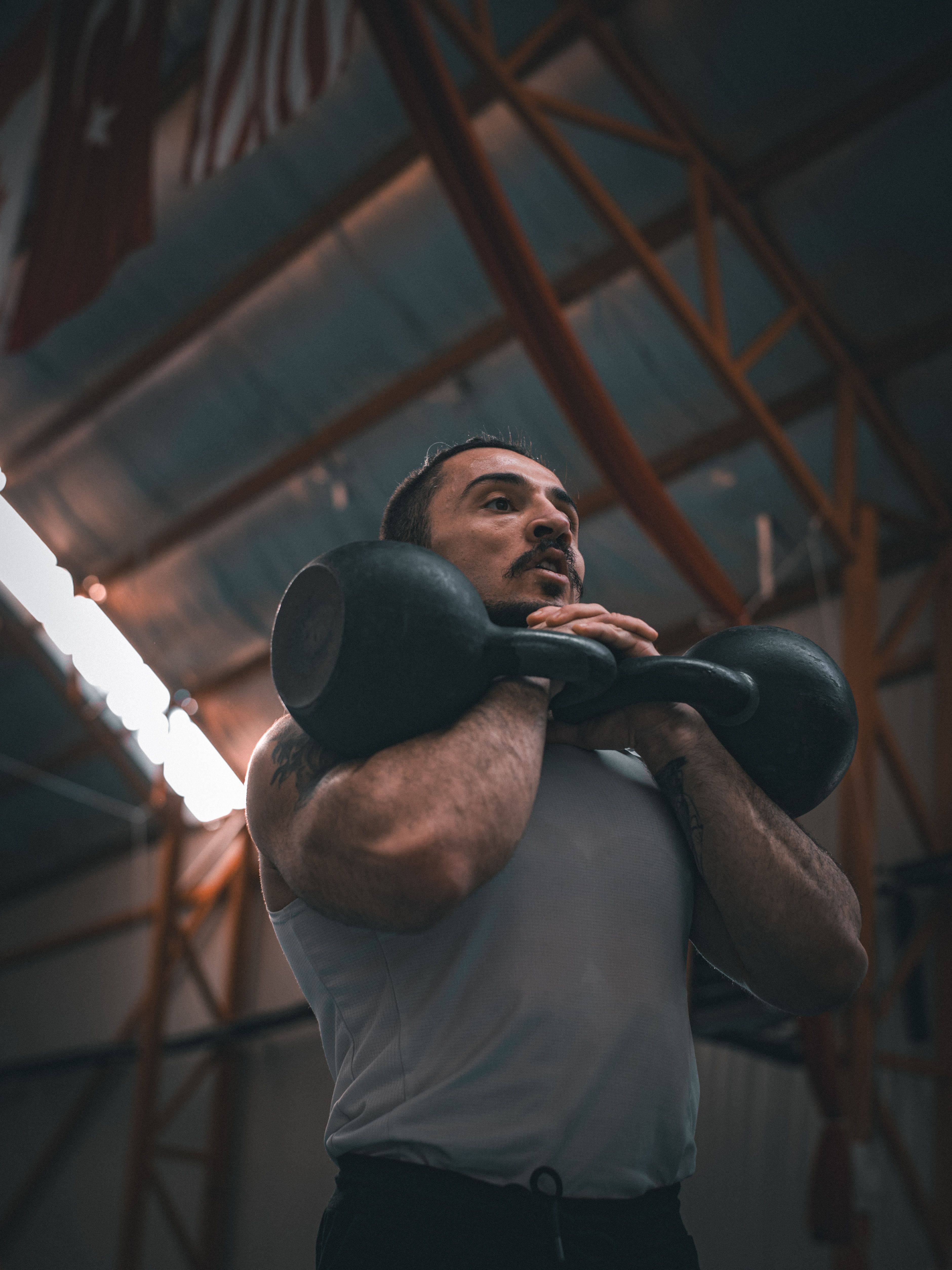 A man lifting weights in a gym · Free Stock Photo