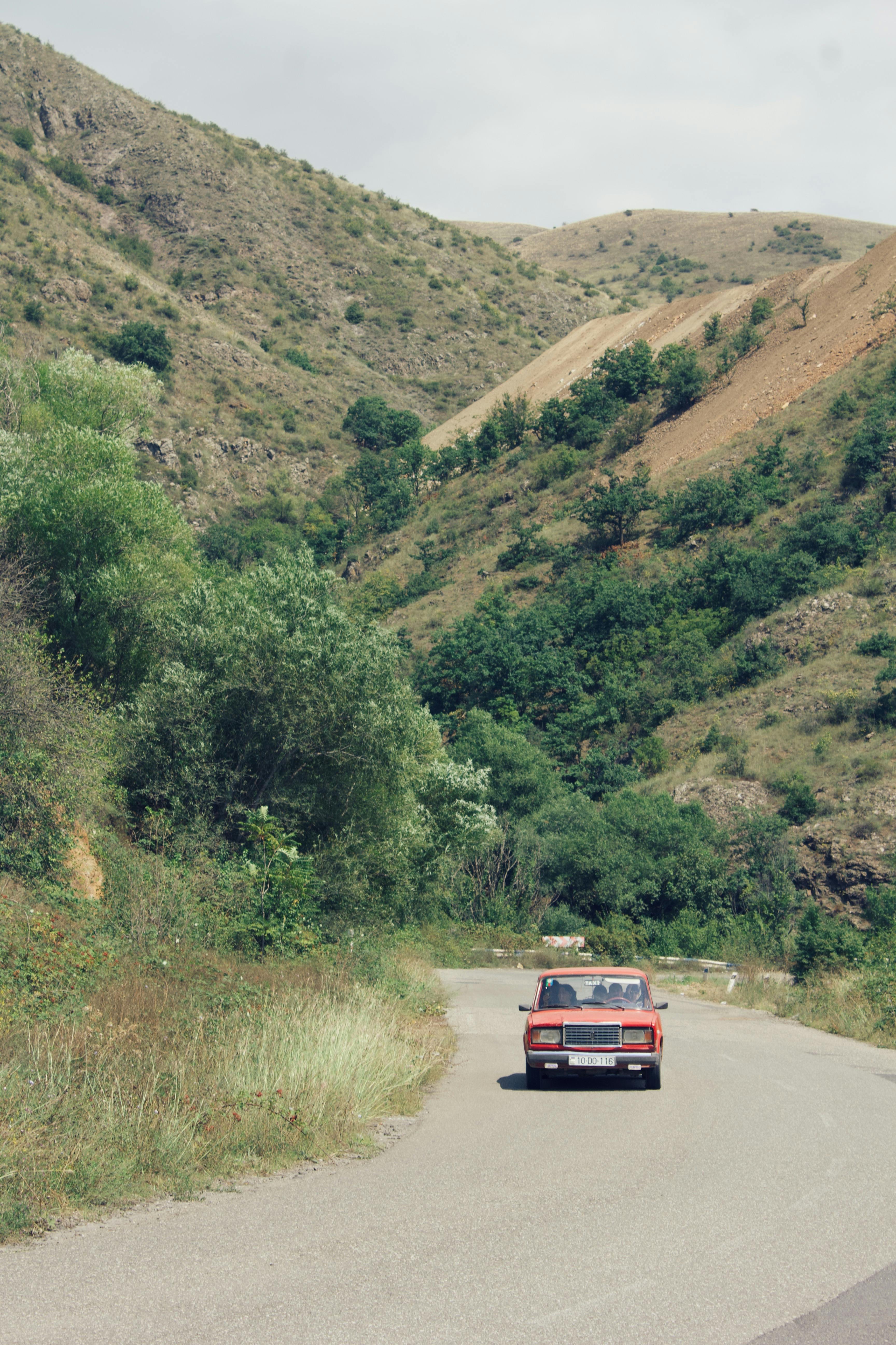 Red Car Travels on the Curved Road · Free Stock Photo