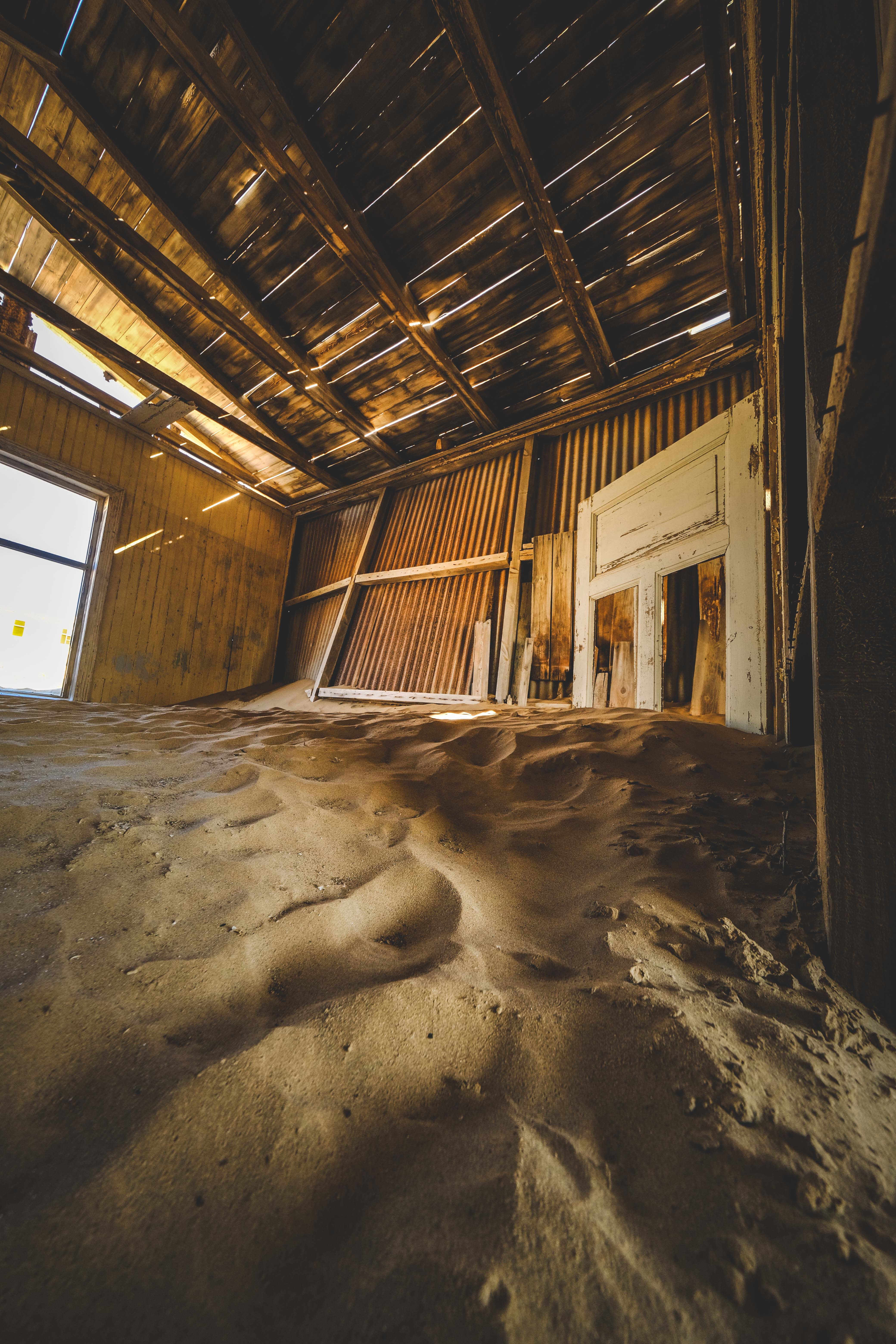 A room with sand in it and a window · Free Stock Photo