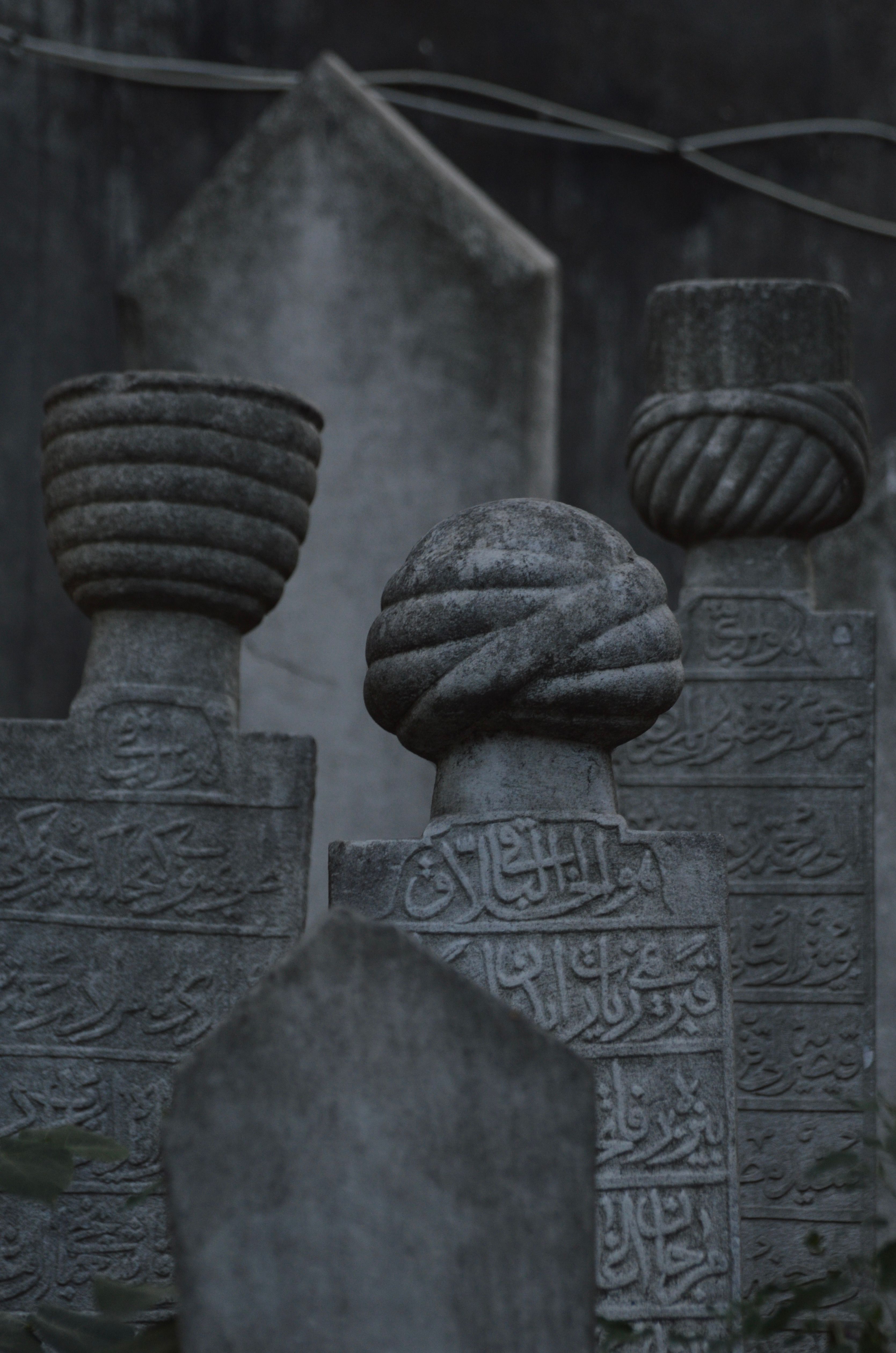 A group of tombstones with arabic writing on them · Free Stock Photo