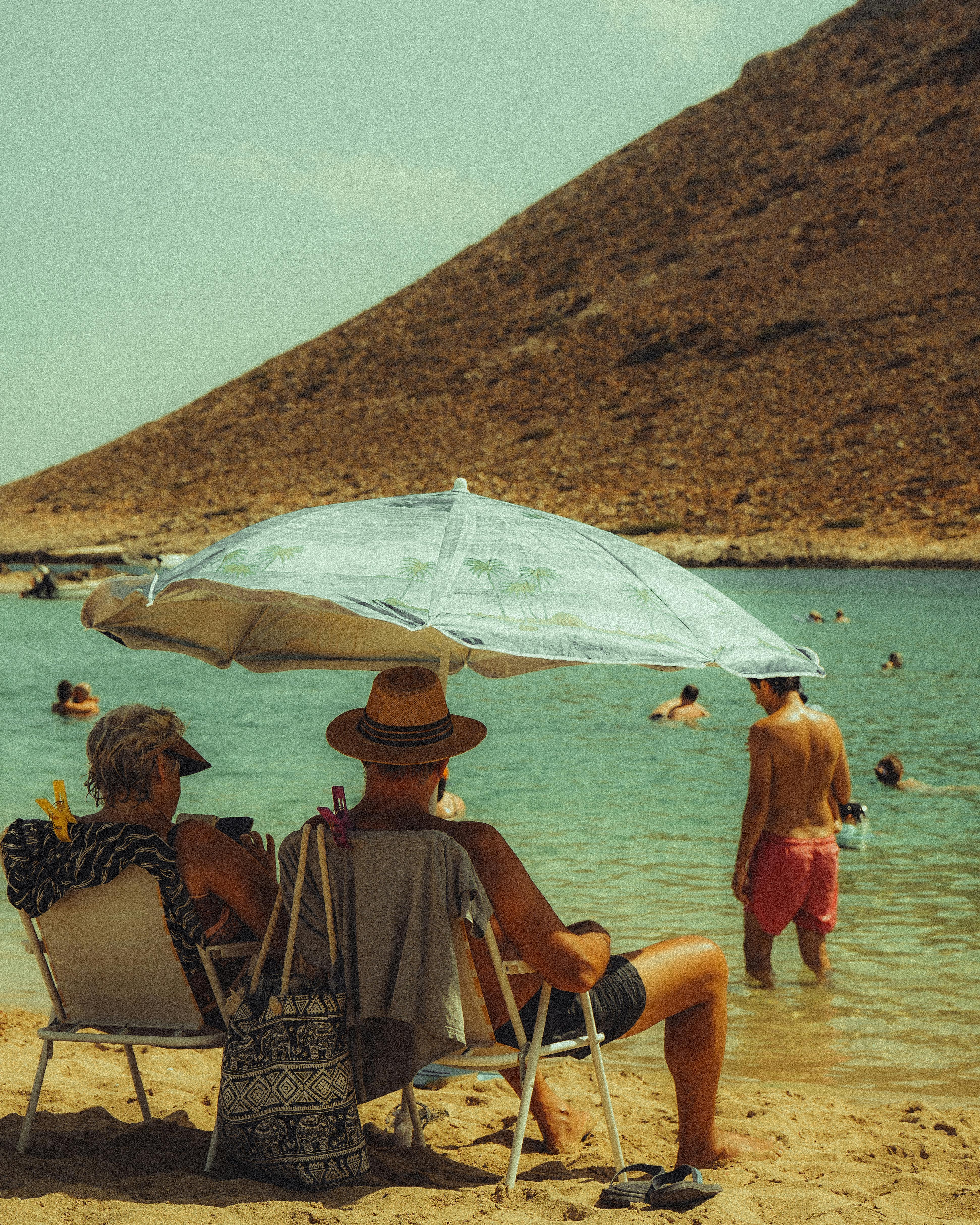 Timeless moments beneath a faded sun. · Free Stock Photo