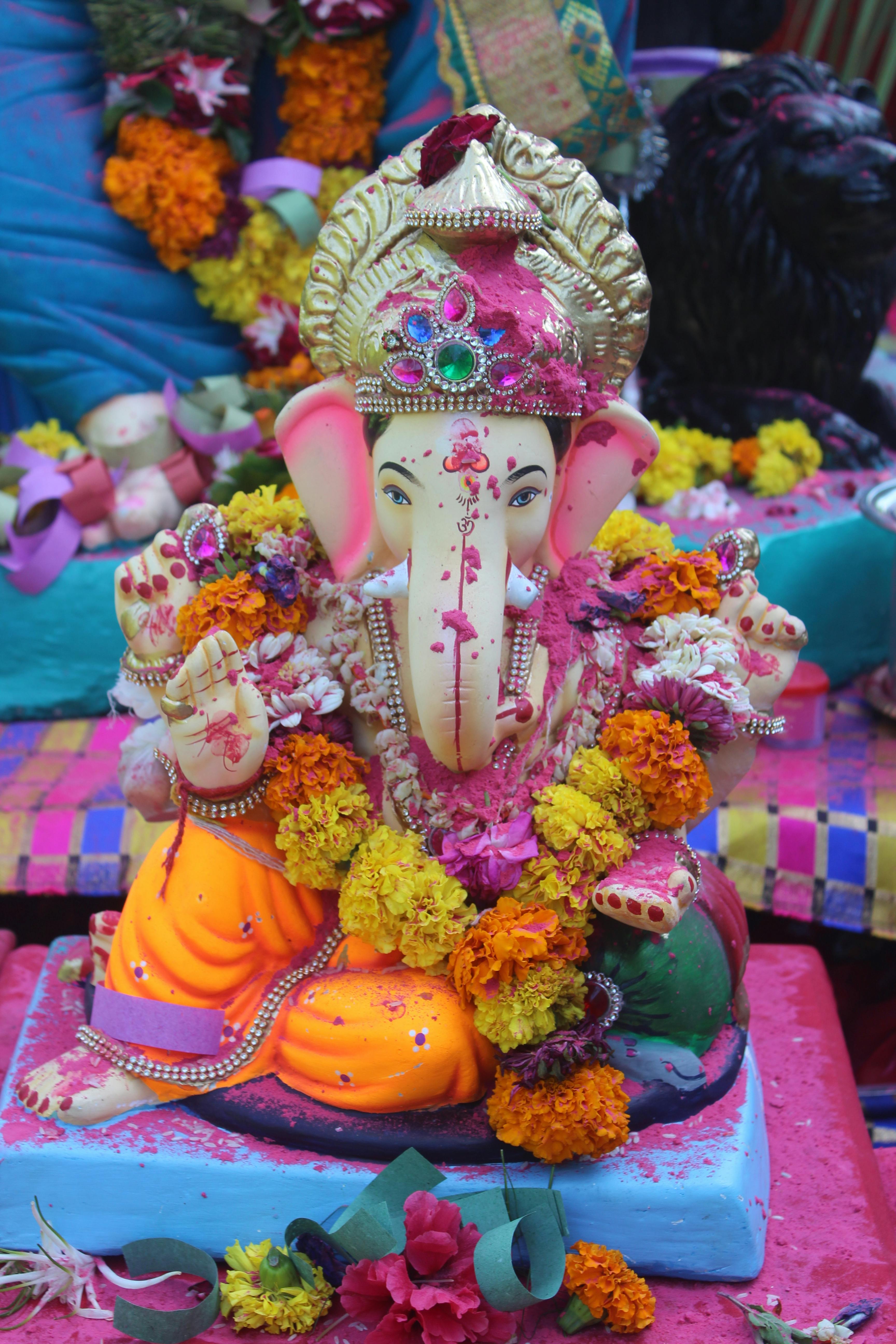 Golden Lord Ganesha Statue with Blue Drapery · Free Stock Photo