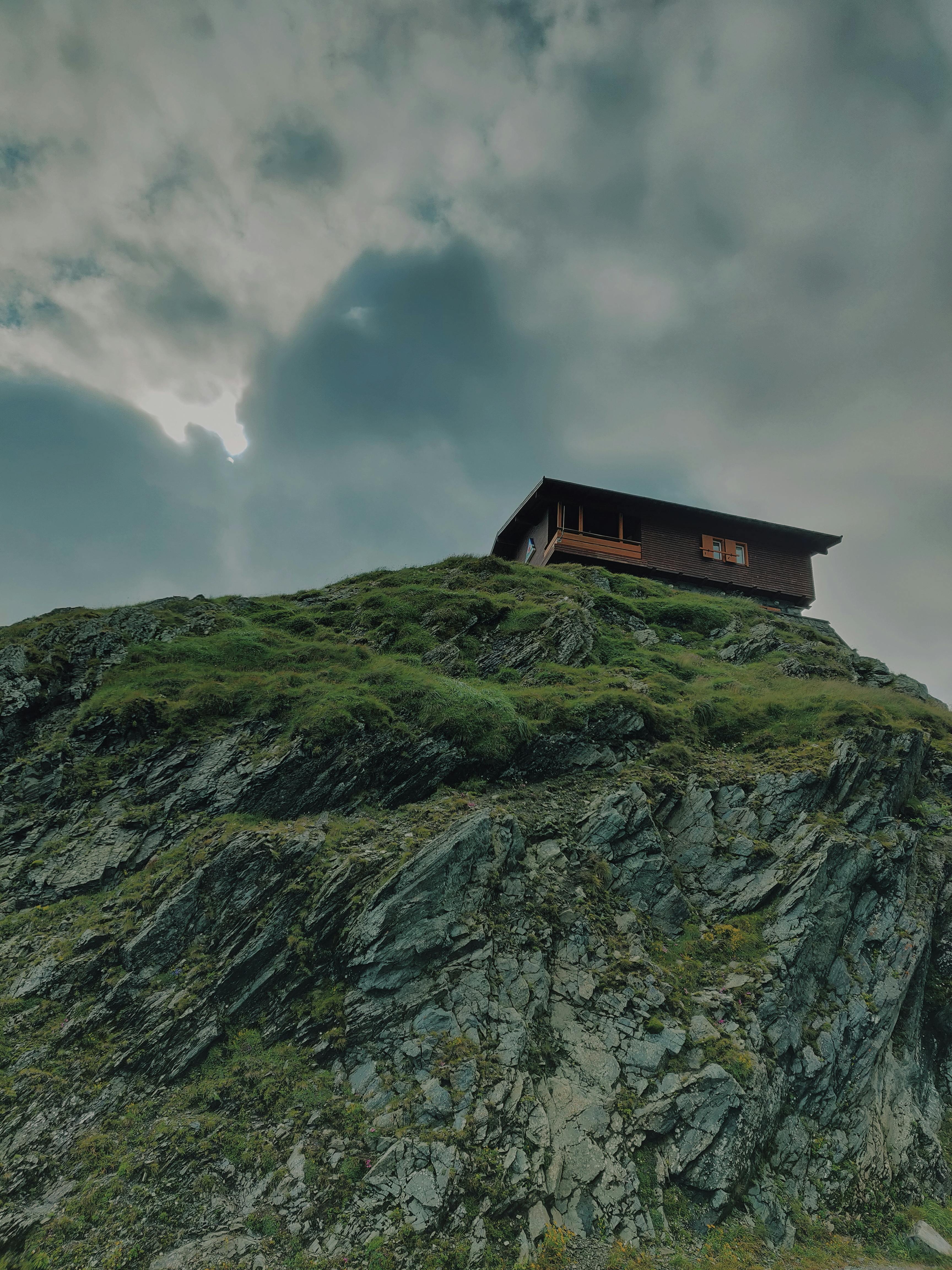 Low Angle Photo Of House On Top Of The Cliff · Free Stock Photo