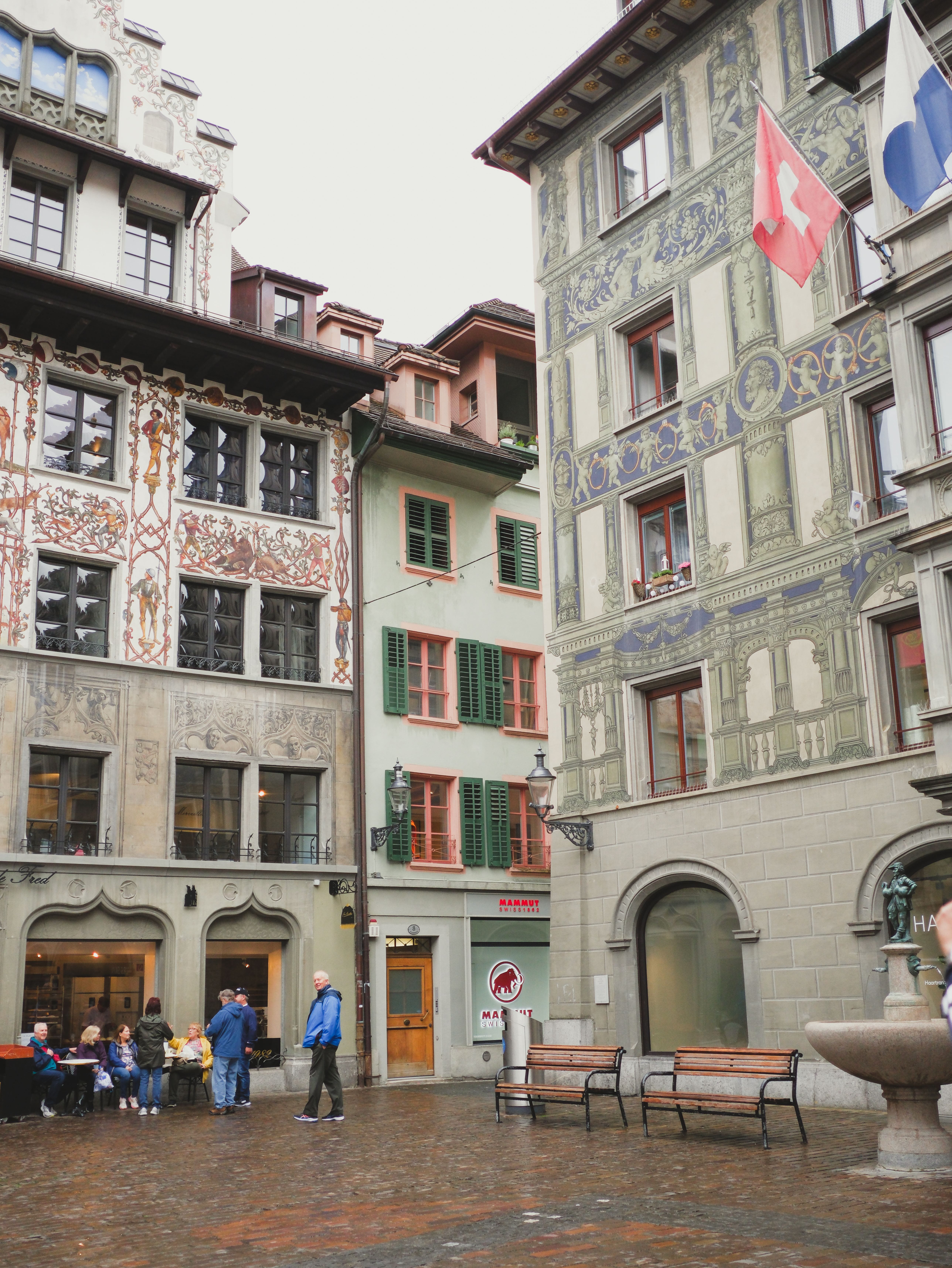 A city street with buildings and people walking around · Free Stock Photo