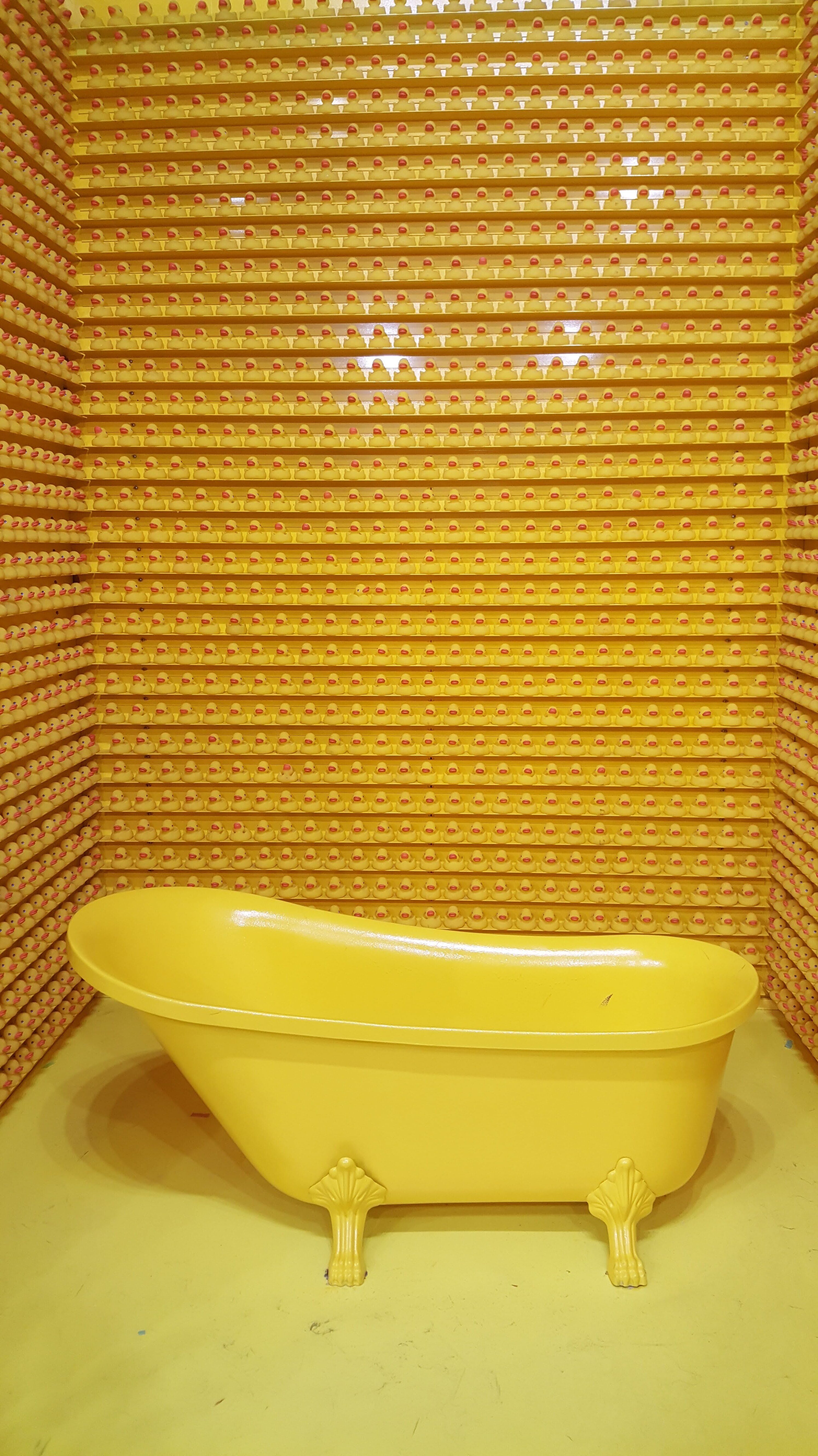A yellow bathtub in a room with yellow walls · Free Stock Photo