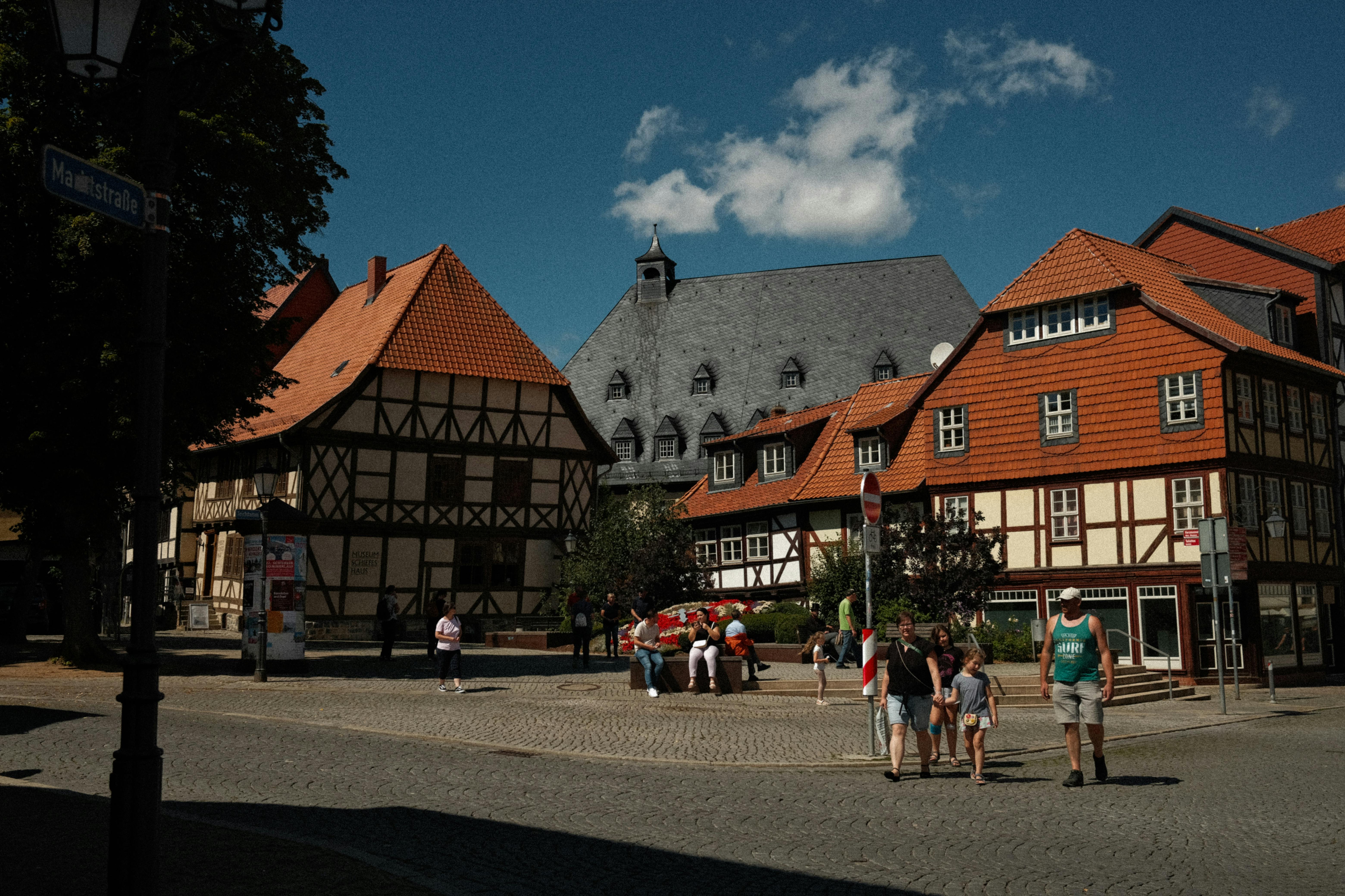 People are walking around a town square with old buildings · Free Stock ...