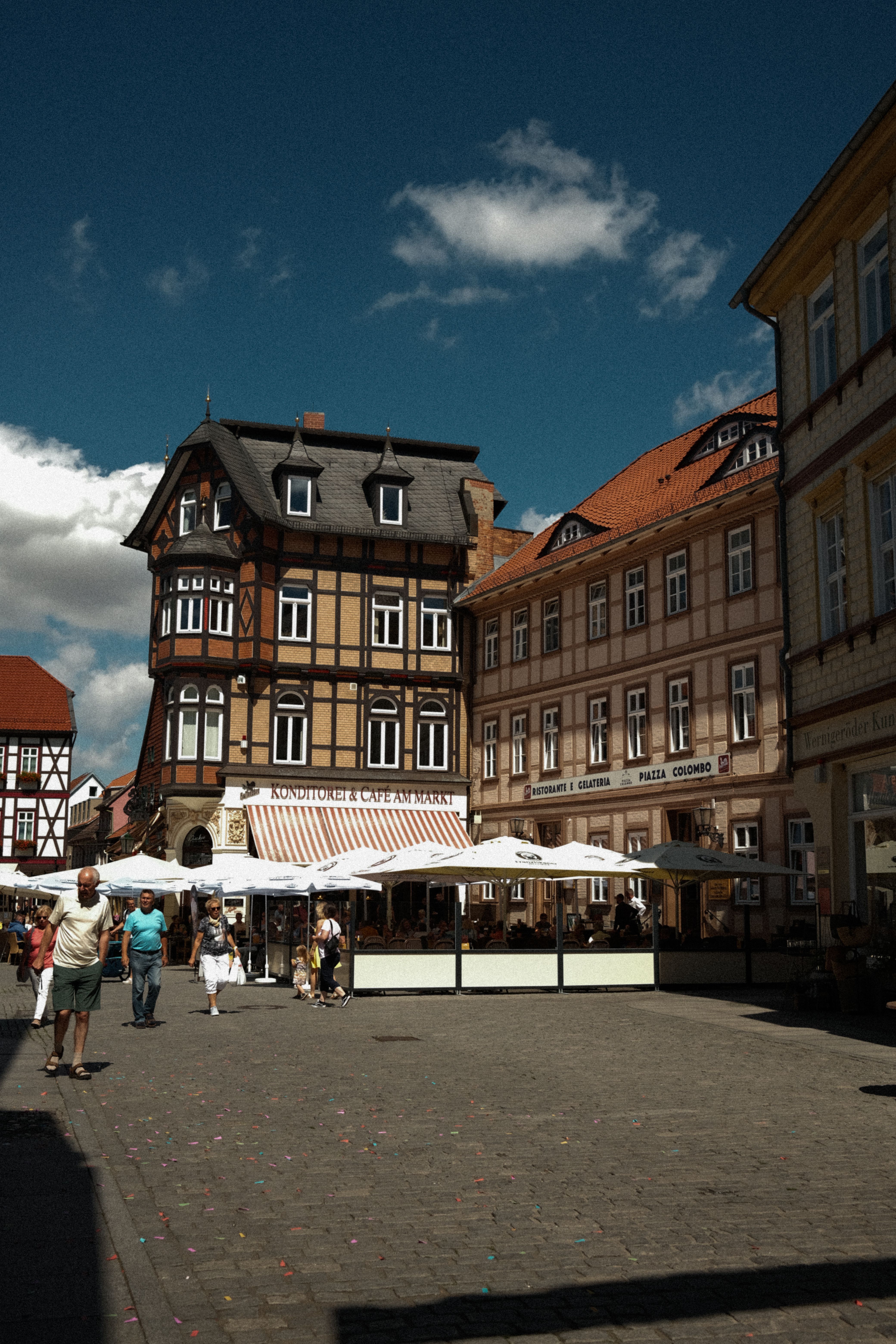 A group of people walking around a town square · Free Stock Photo