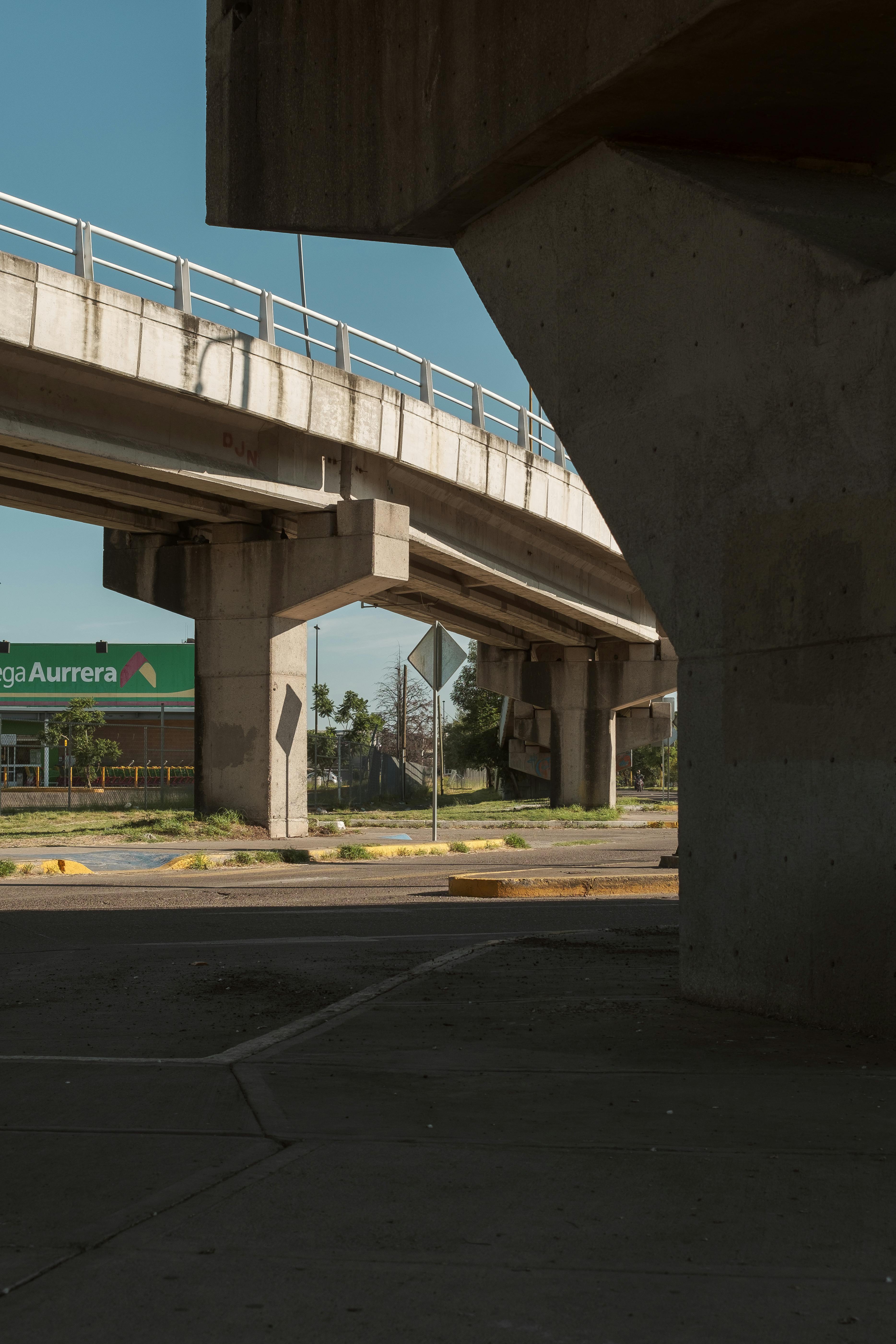 A view of a highway underpass with a car driving under it · Free Stock ...