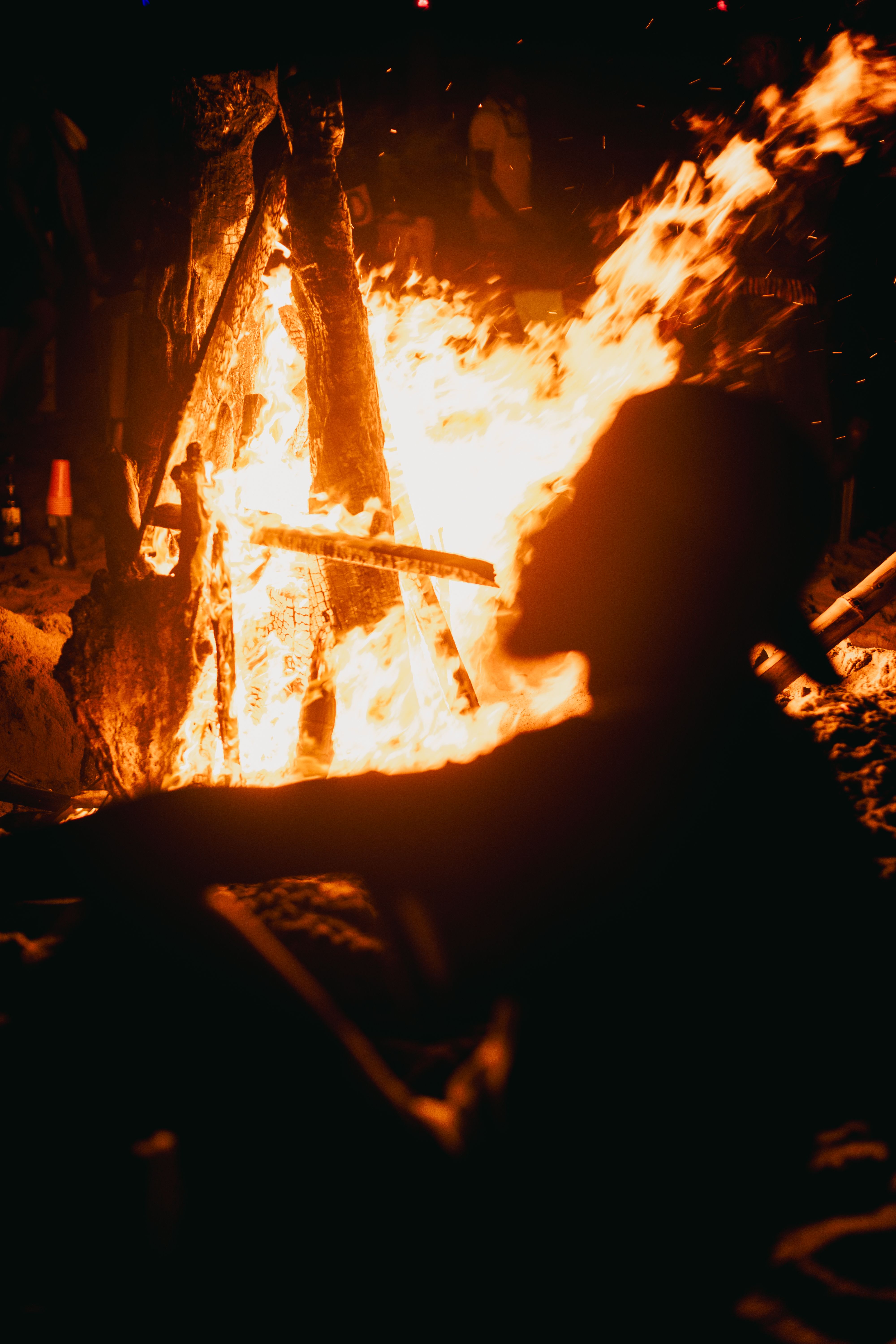 A person sitting in front of a bonfire · Free Stock Photo