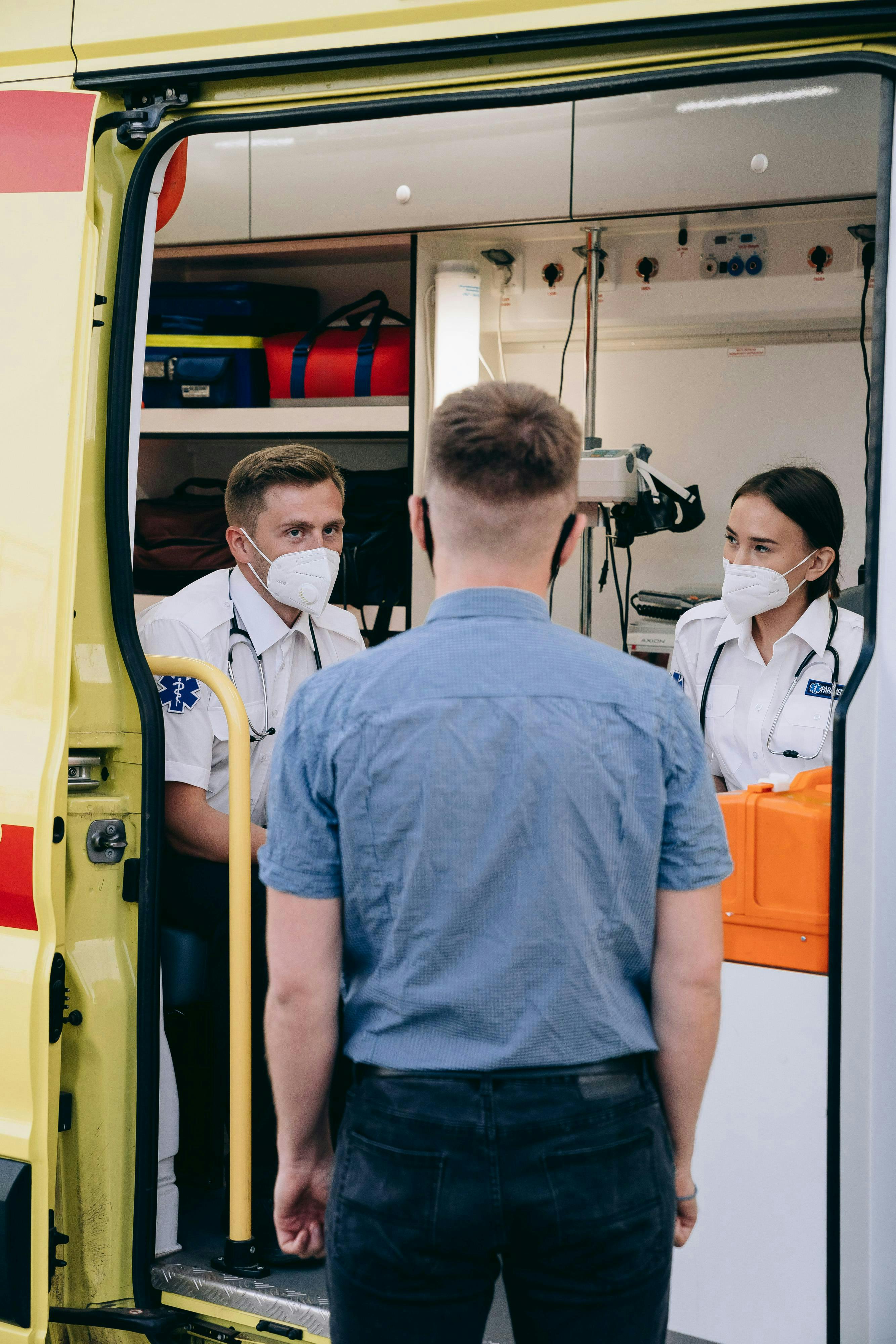 Paramedics Talking with Casualty · Free Stock Photo