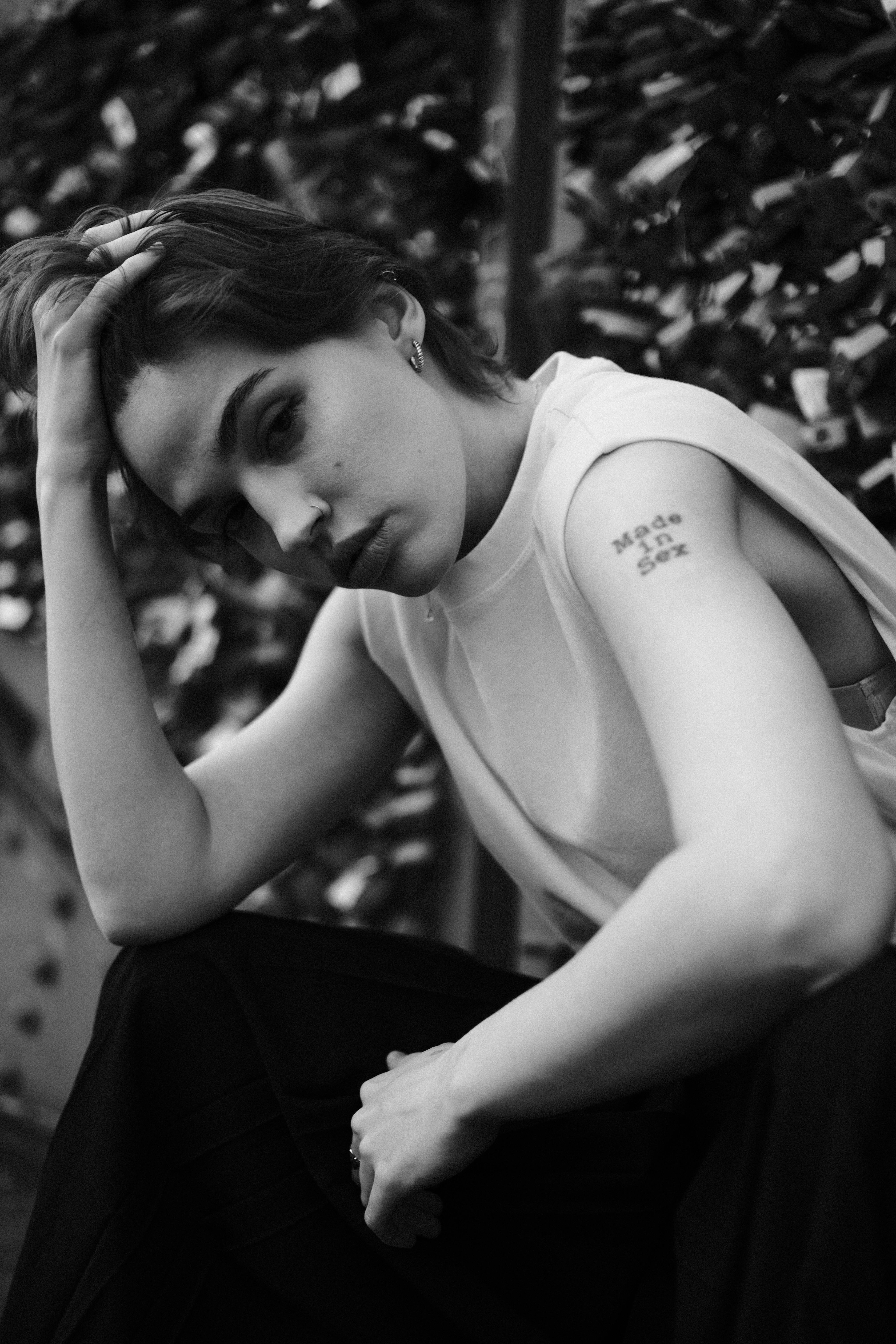 A woman with tattoos sitting on a bench · Free Stock Photo