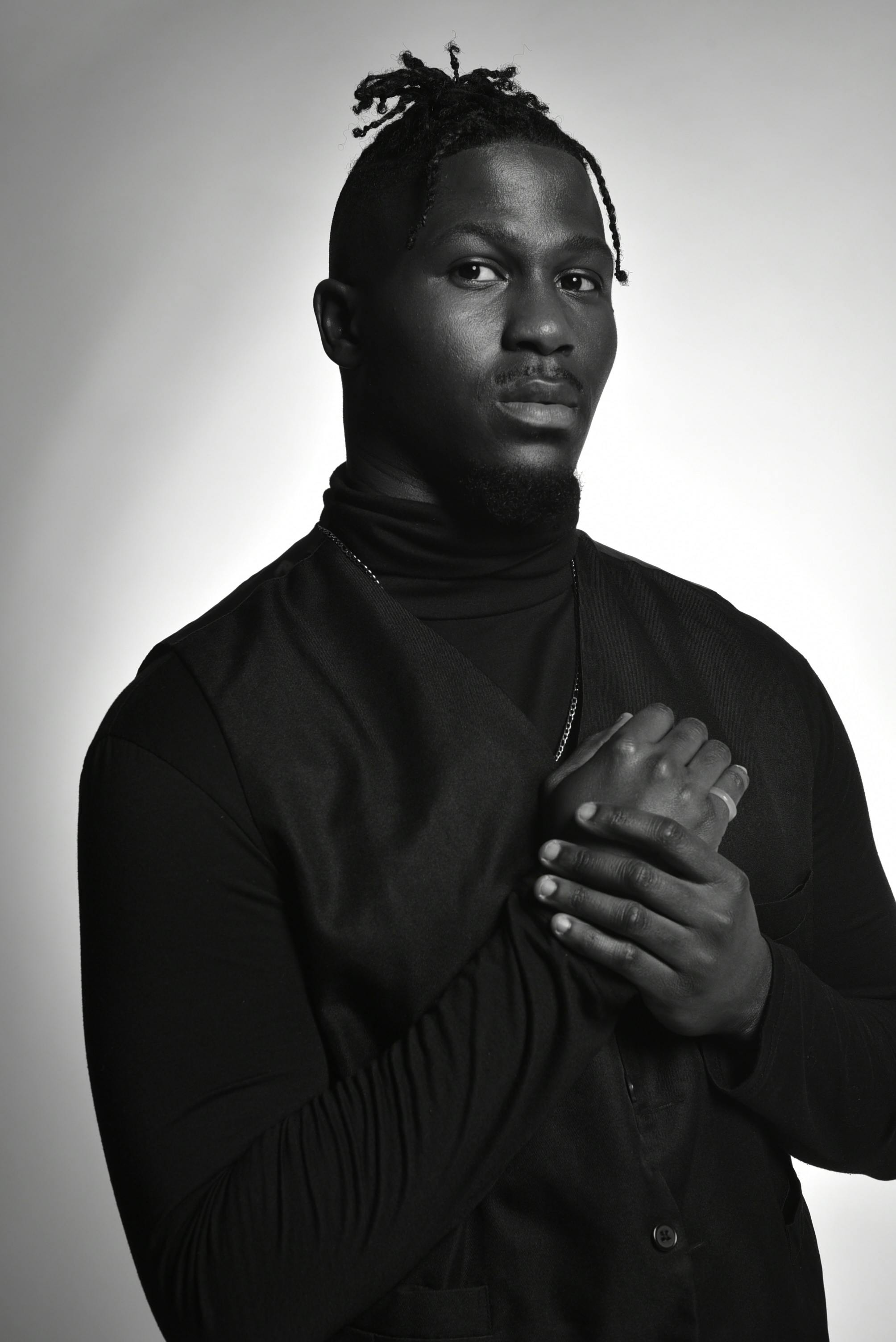 A black man with his hands on his chest · Free Stock Photo