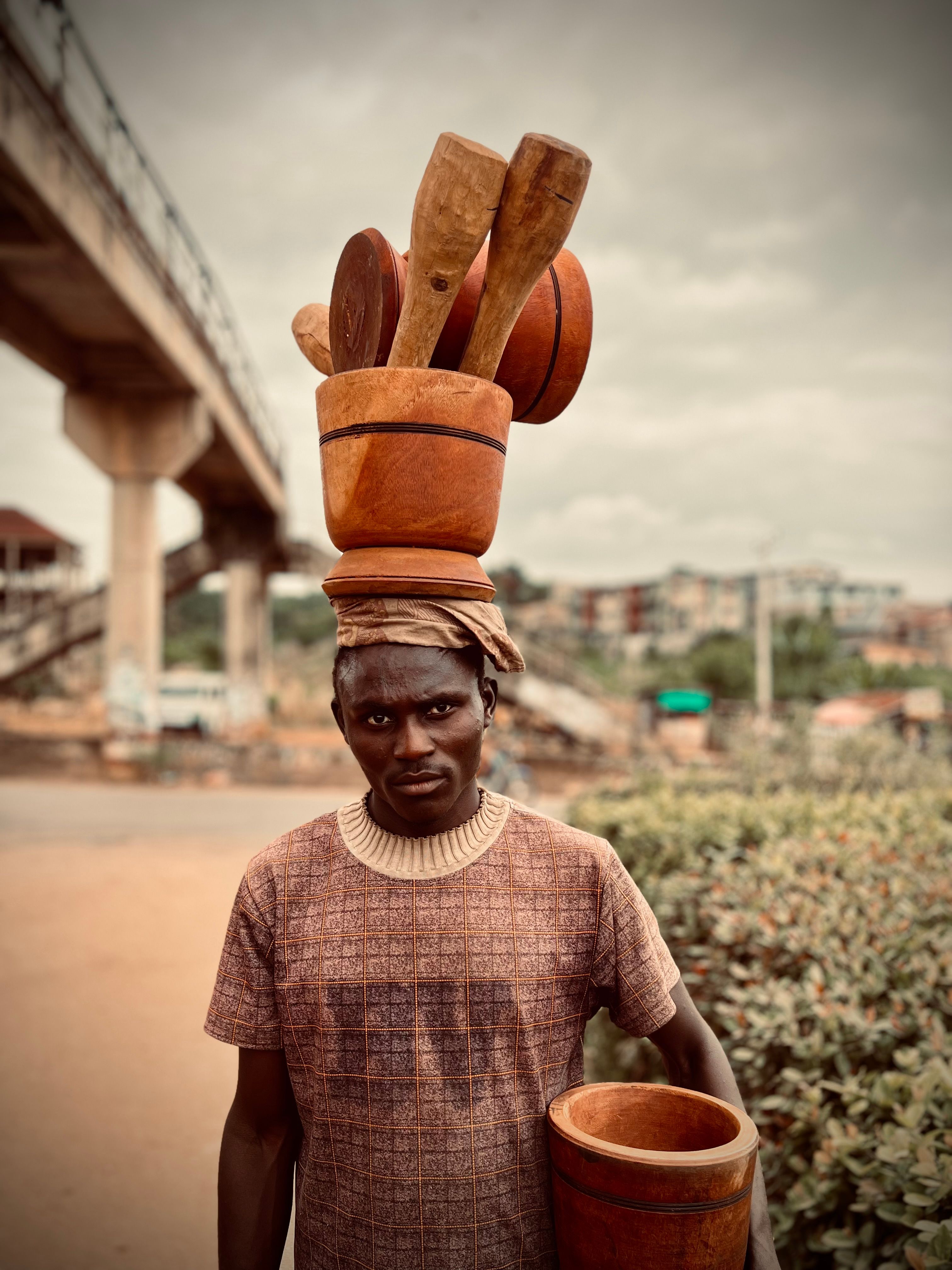 A man carrying pots on his head · Free Stock Photo