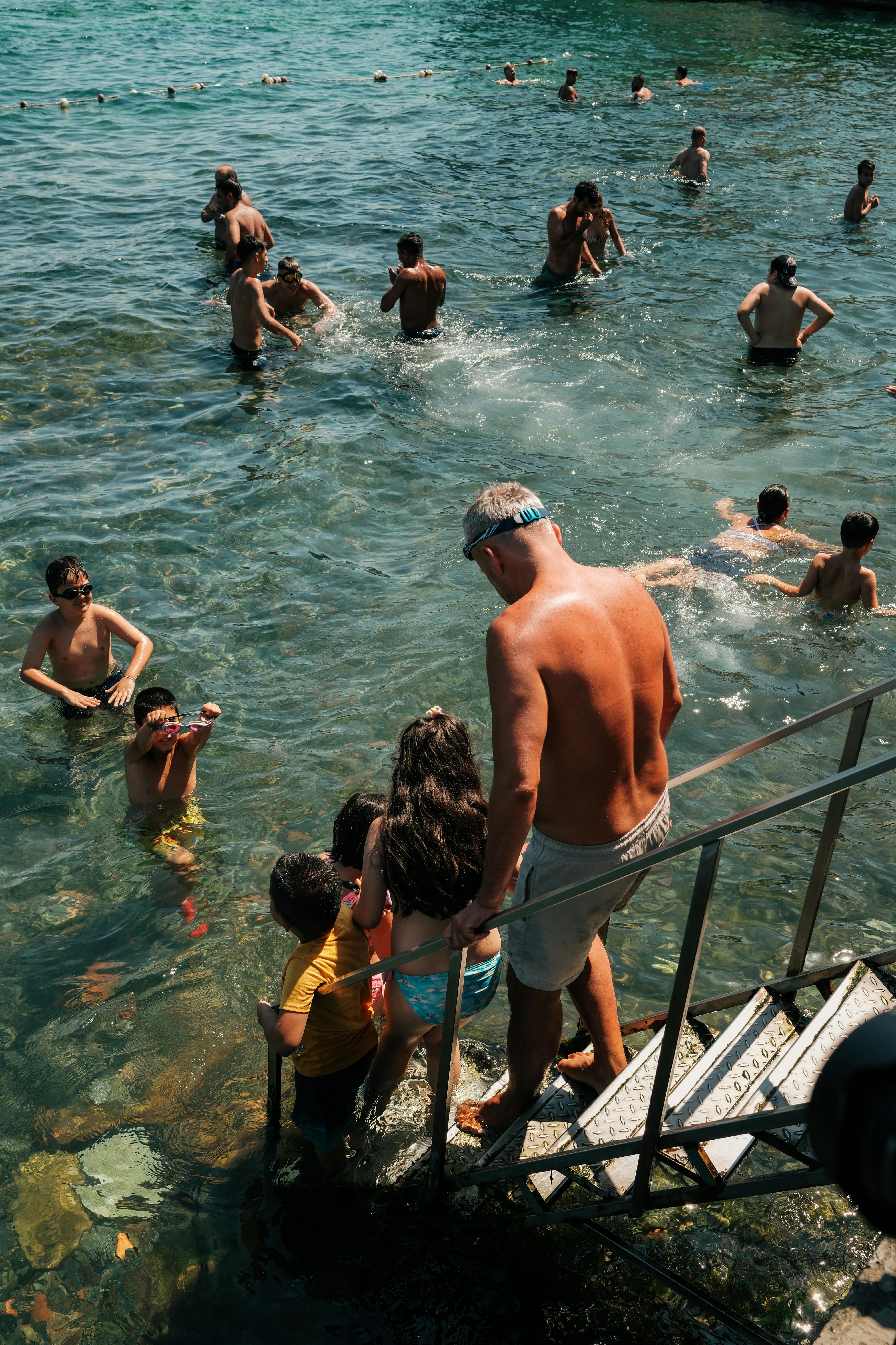 Two Kids Standing on Seashore Under Blue Sky · Free Stock Photo