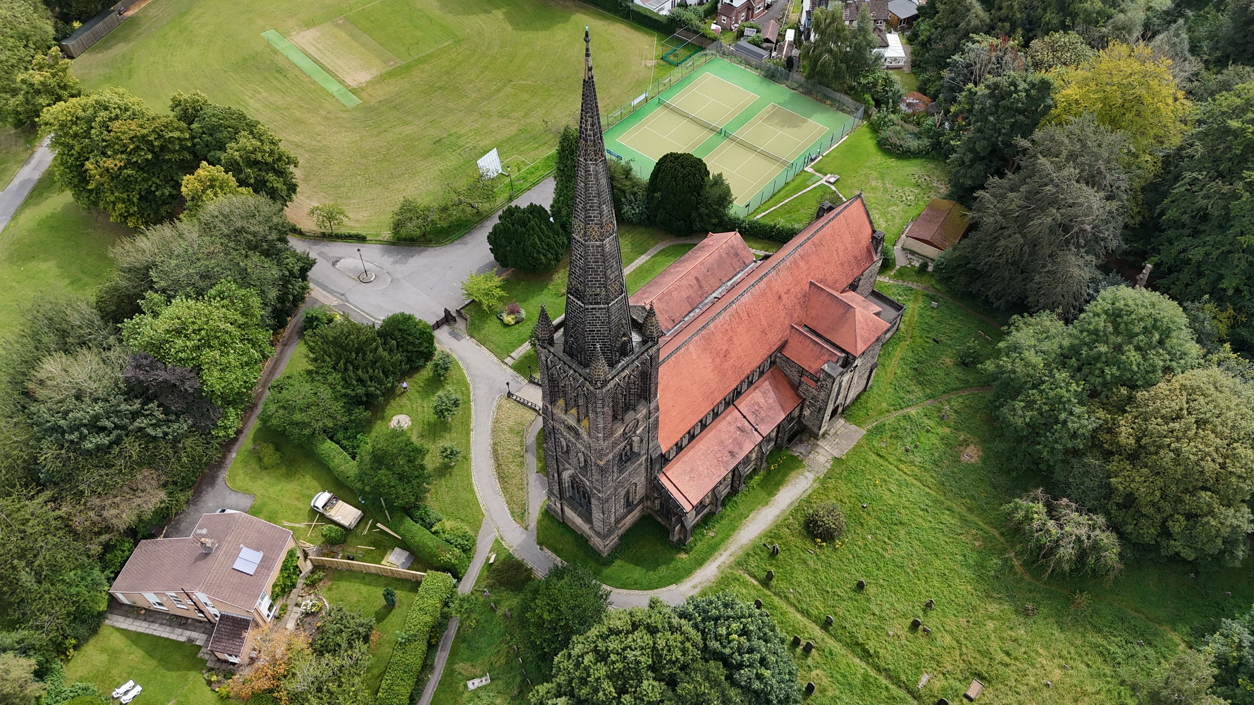 An aerial view of a church and a field · Free Stock Photo