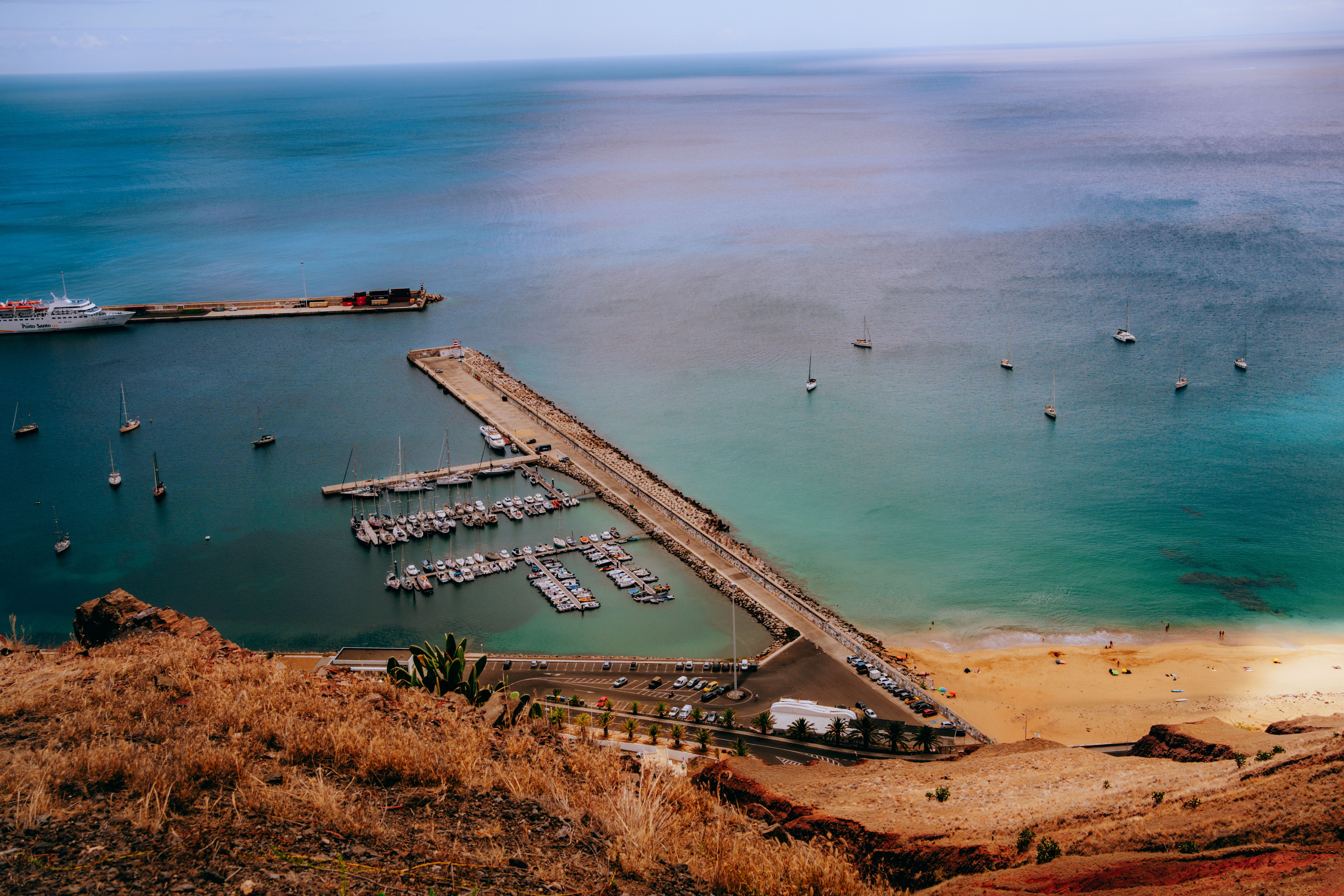 A view of a beach and harbor from above · Free Stock Photo