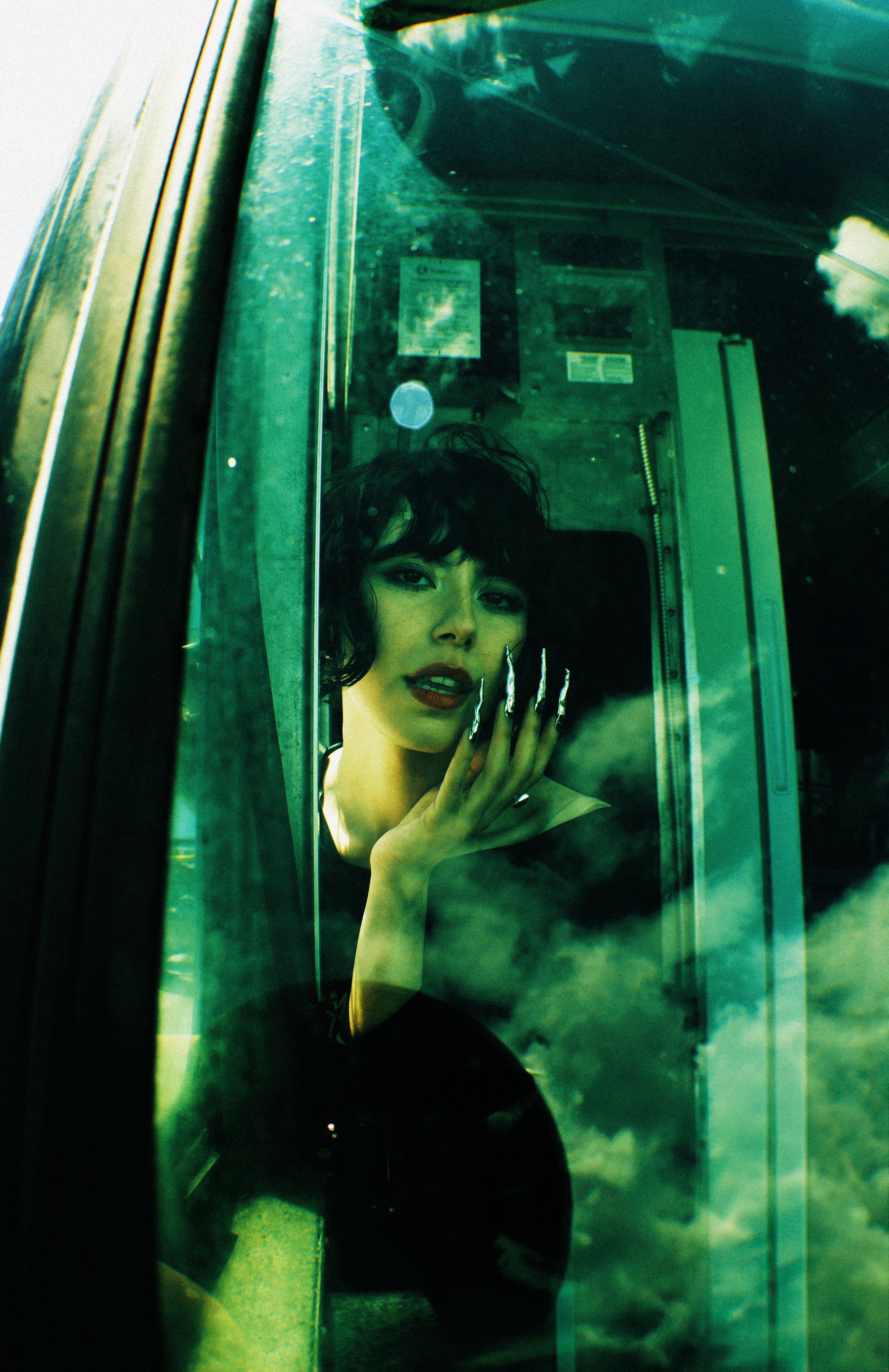 Reflection of a Woman Through a Car Window · Free Stock Photo