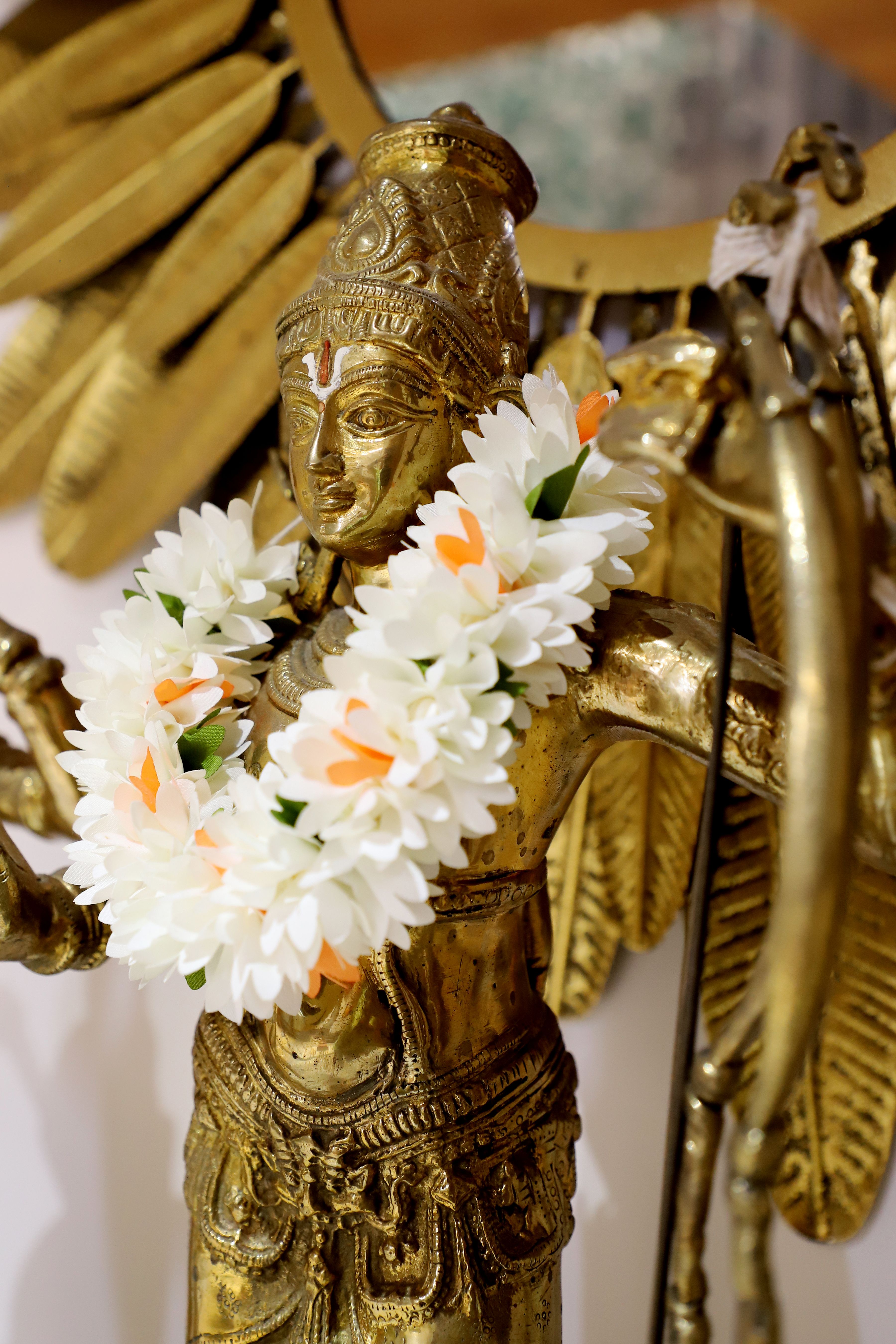 A statue of a god with a flower garland · Free Stock Photo