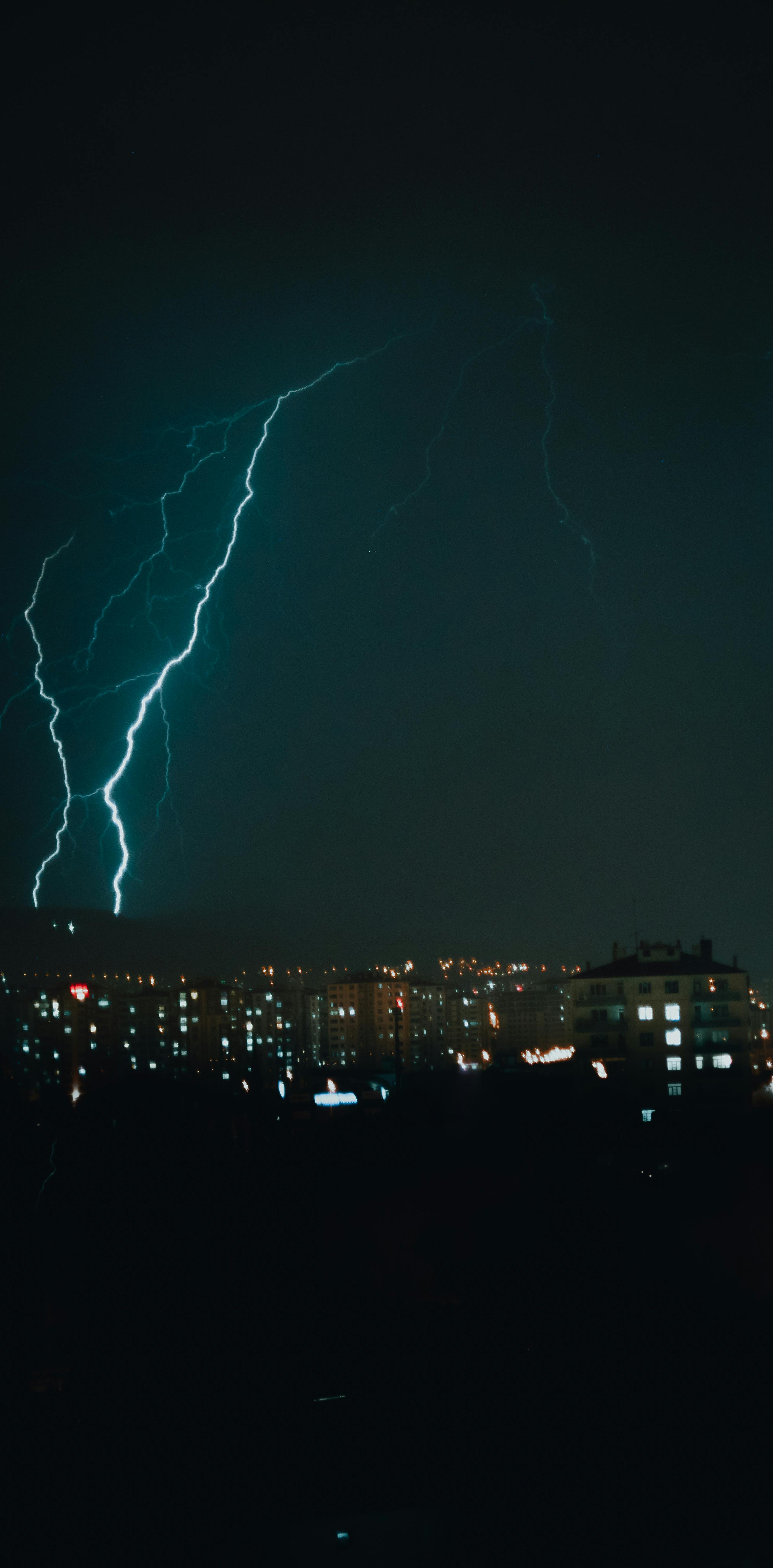 Lightning bolt over city night · Free Stock Photo