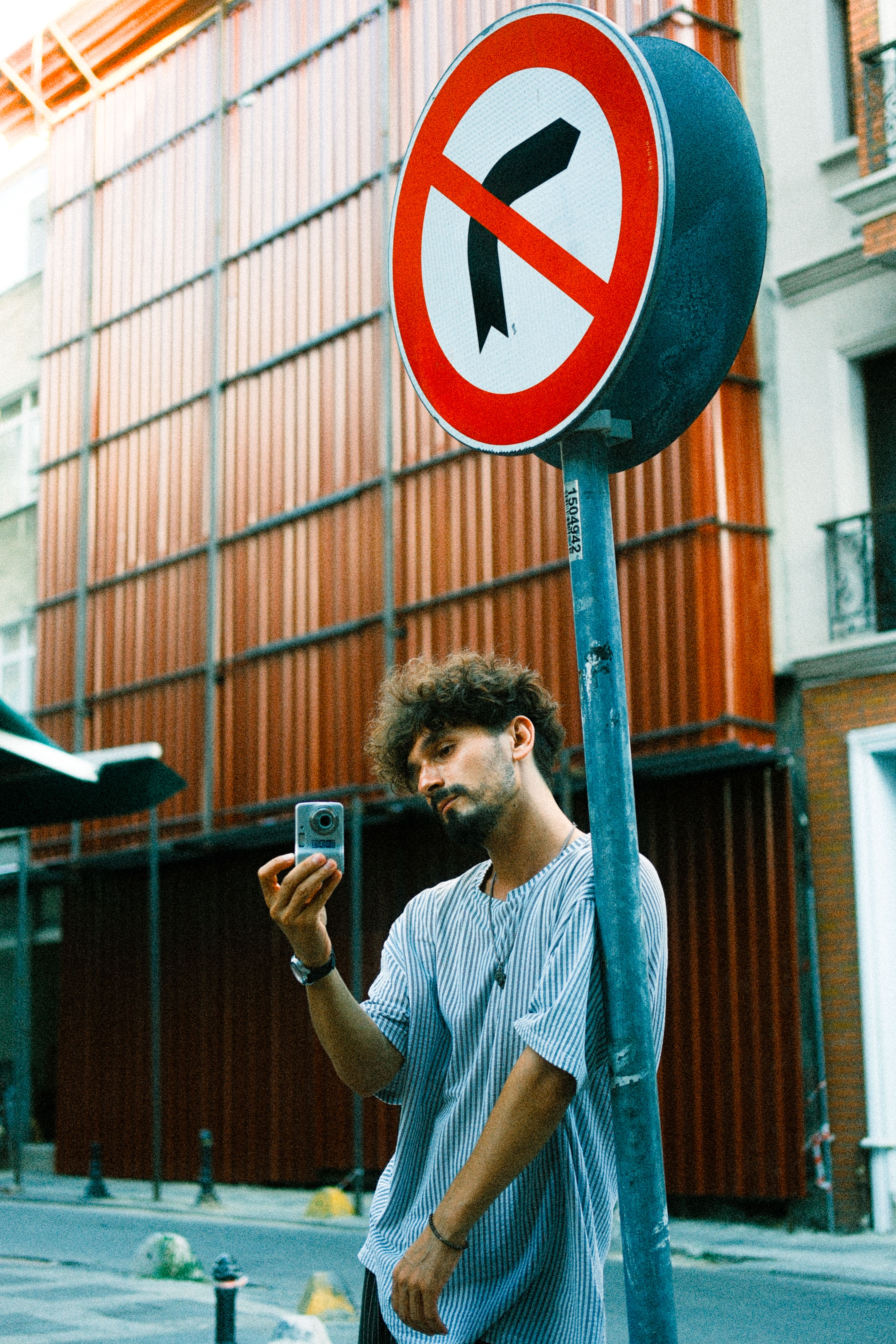 A man taking a picture of a street sign · Free Stock Photo