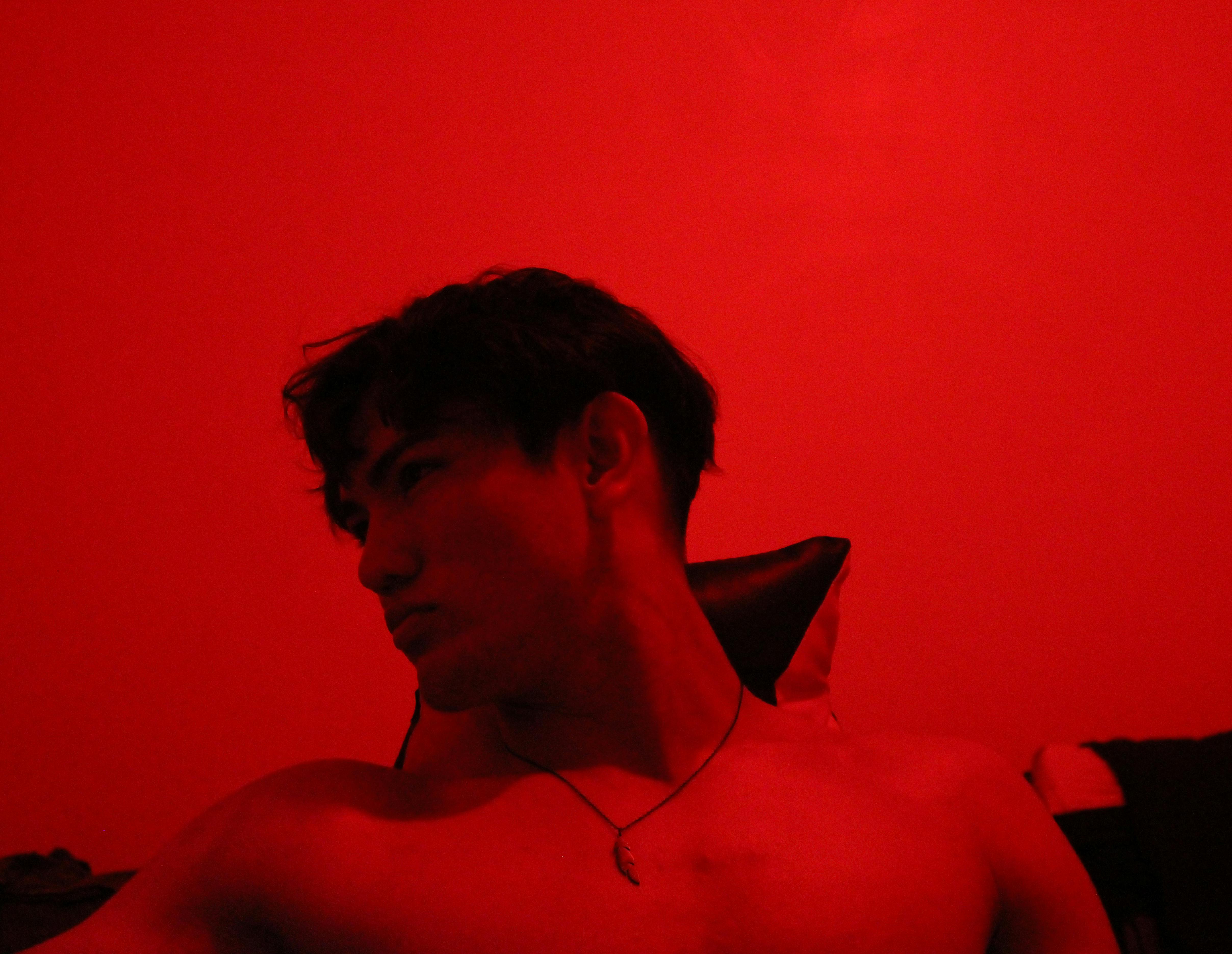 A shirtless man in red light · Free Stock Photo